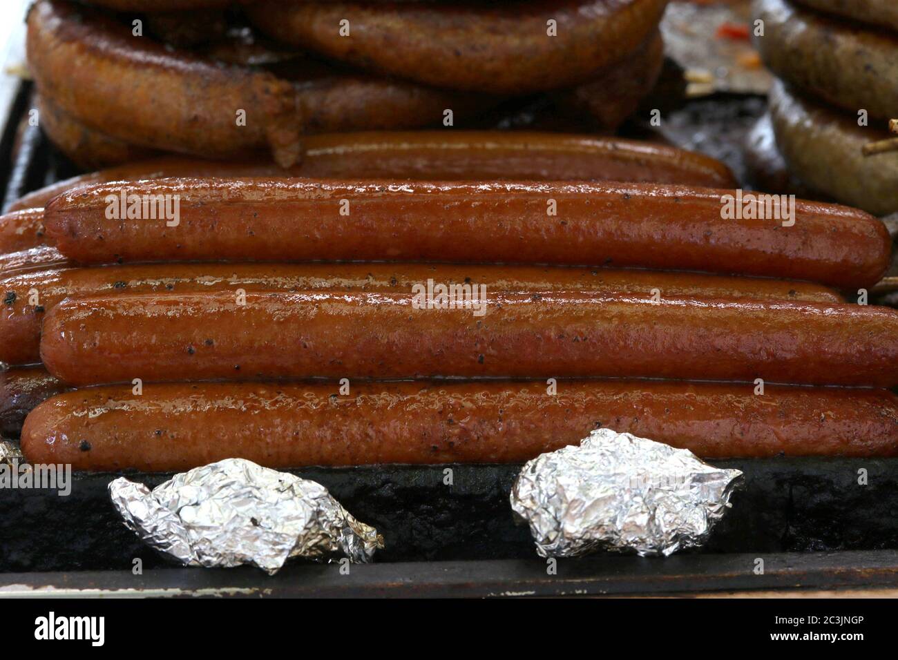 Hot dogs with seasonings on grill Stock Photo - Alamy