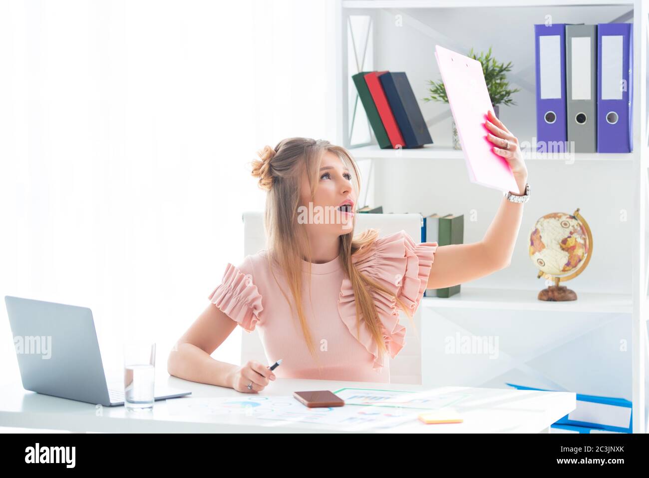 Surprised business woman working in the office at the table Stock Photo ...