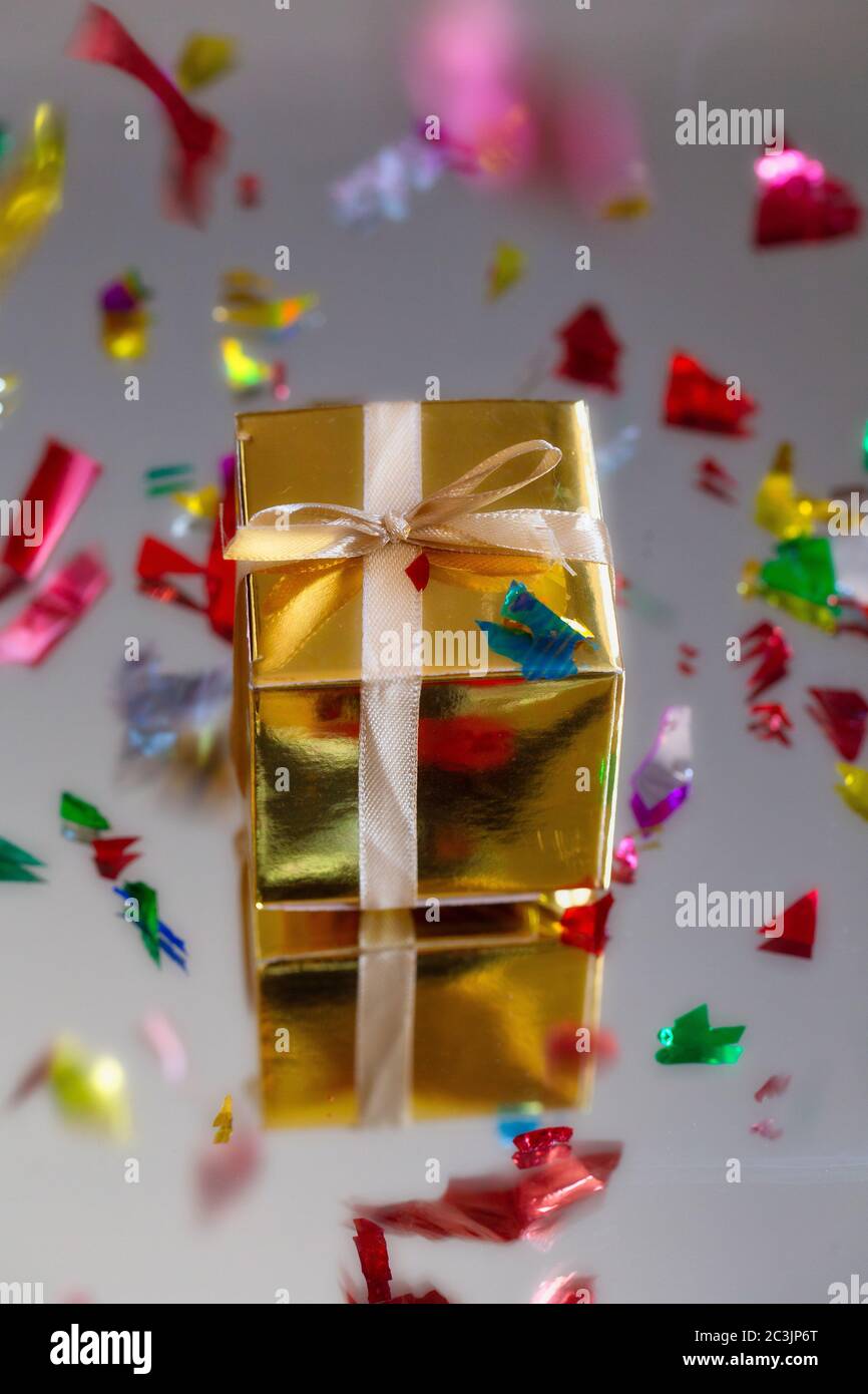 Group of gold sparkling gift boxes on grey background with reflection ...