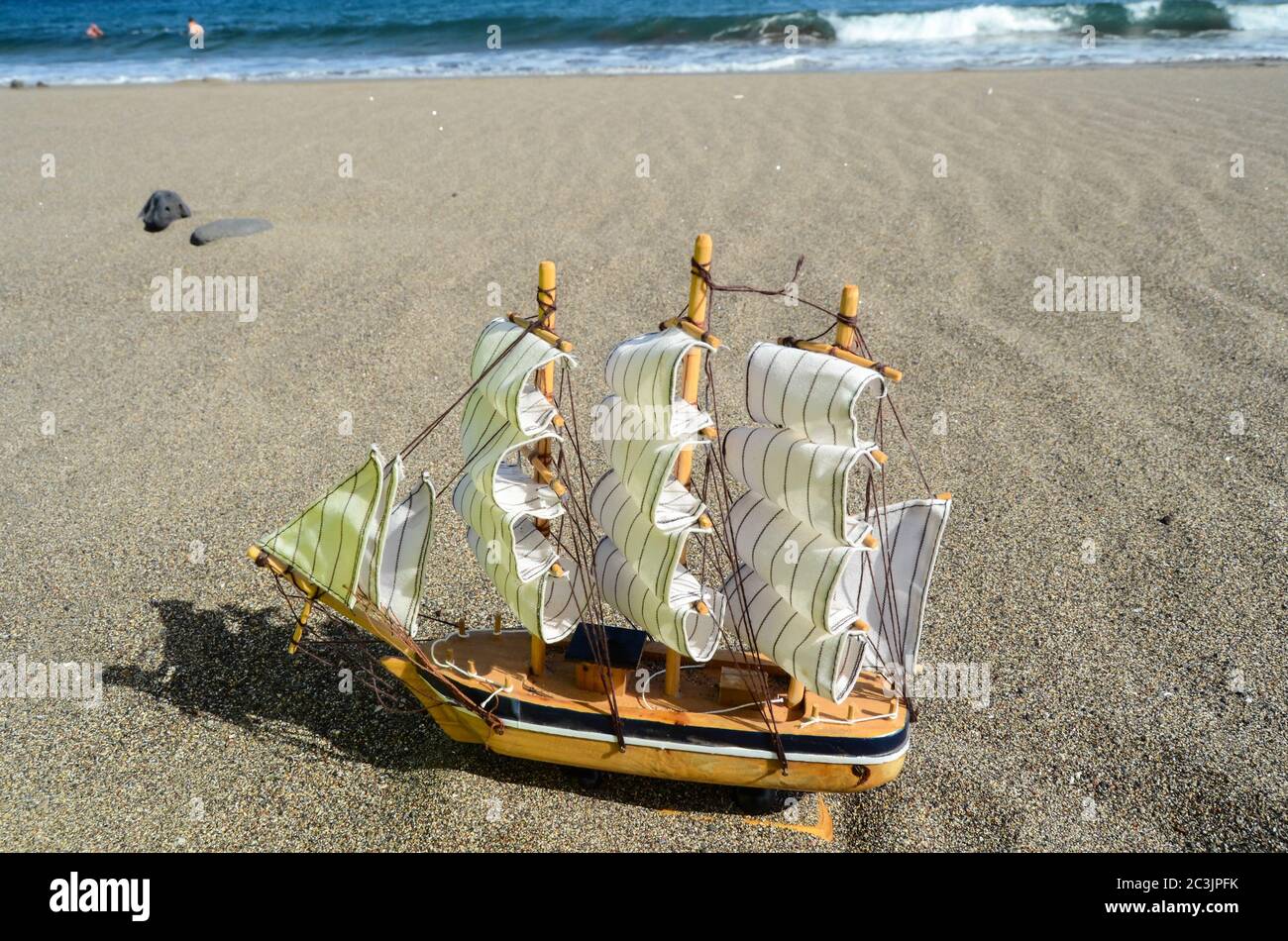 Sail Ship Toy Model in the Beach Sand Close-up Stock Photo - Alamy