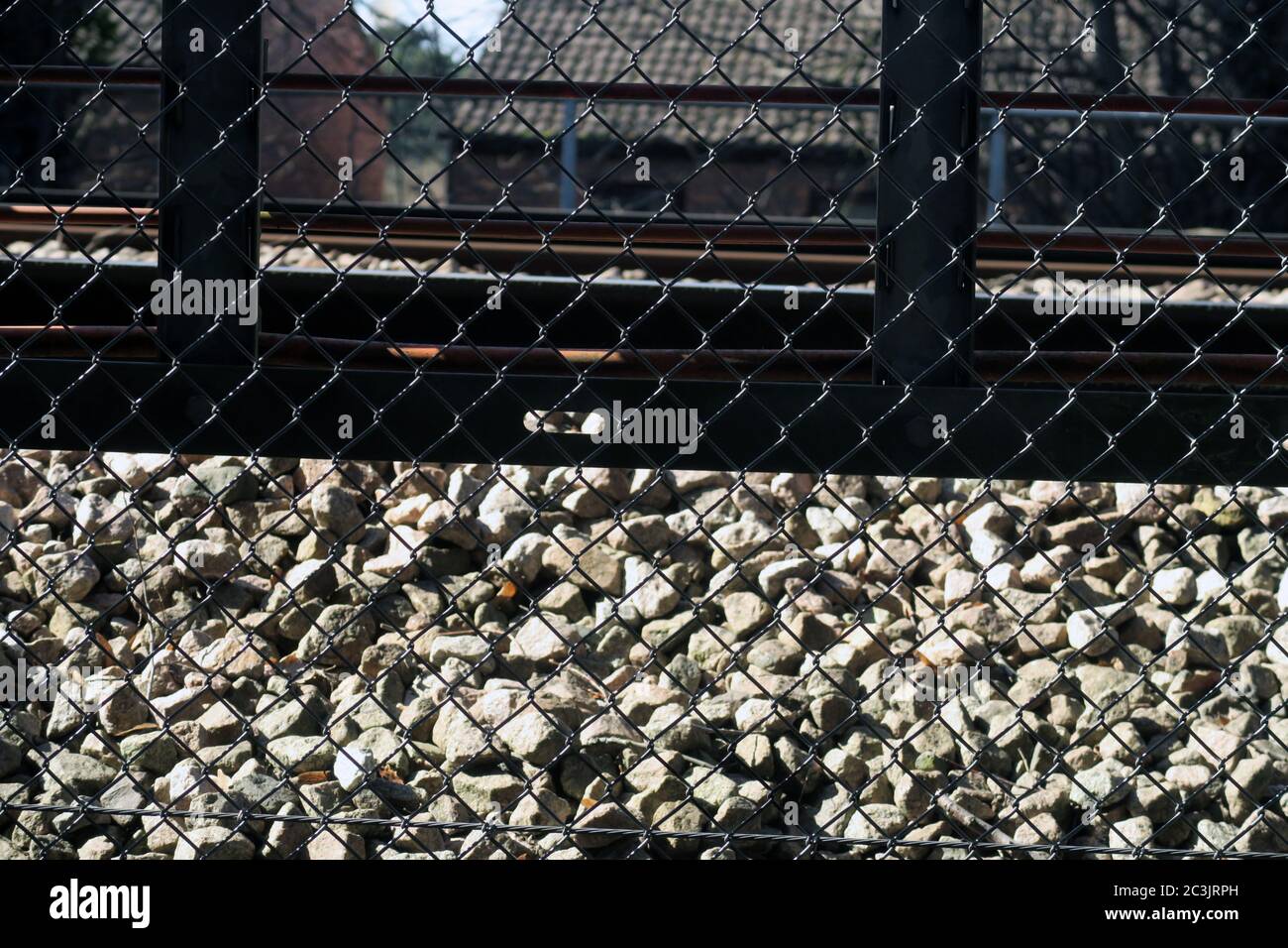 Wire-mesh fence separating tube rails from pedestrian path in London ...