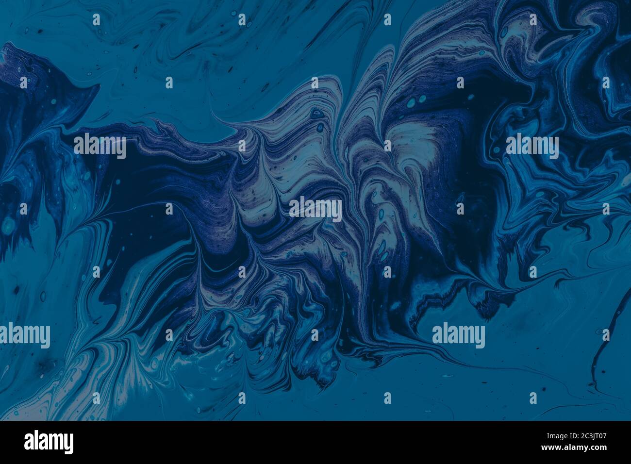 An overhead shot capturing light and dark blue color splashes, that can ...