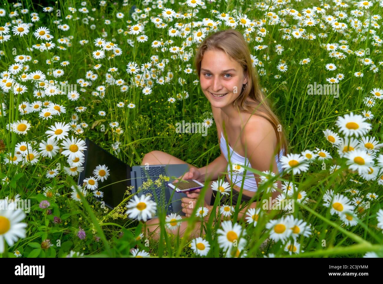 Female sitting in daisies hi-res stock photography and images - Alamy