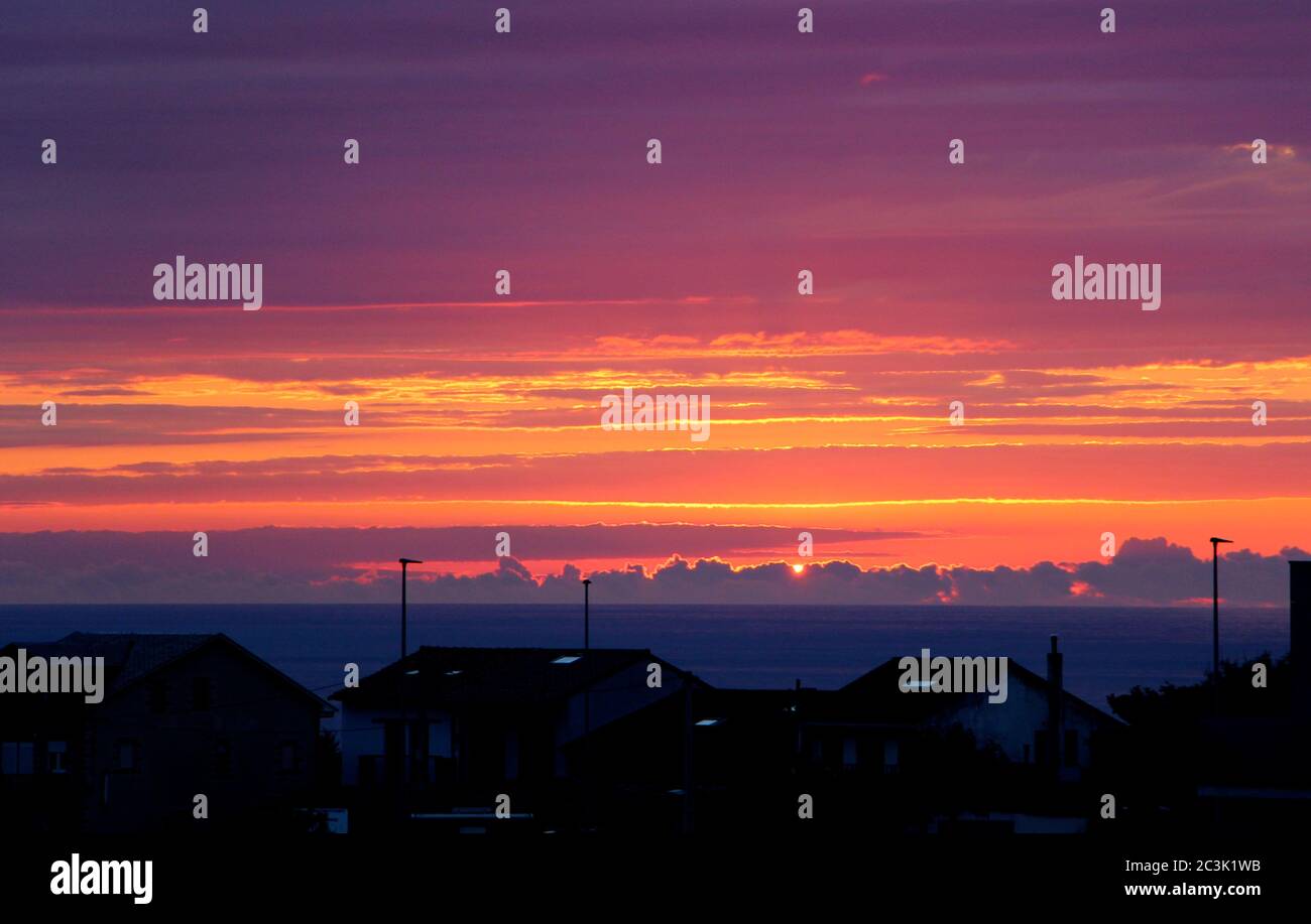 Sunset with extreme colours and urban silhouette Stock Photo - Alamy