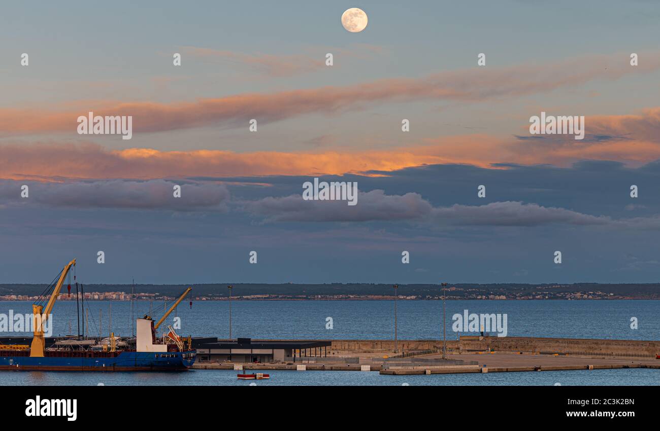 Amazing view of bright full moon in cloudy sky over the bay of Palma de ...