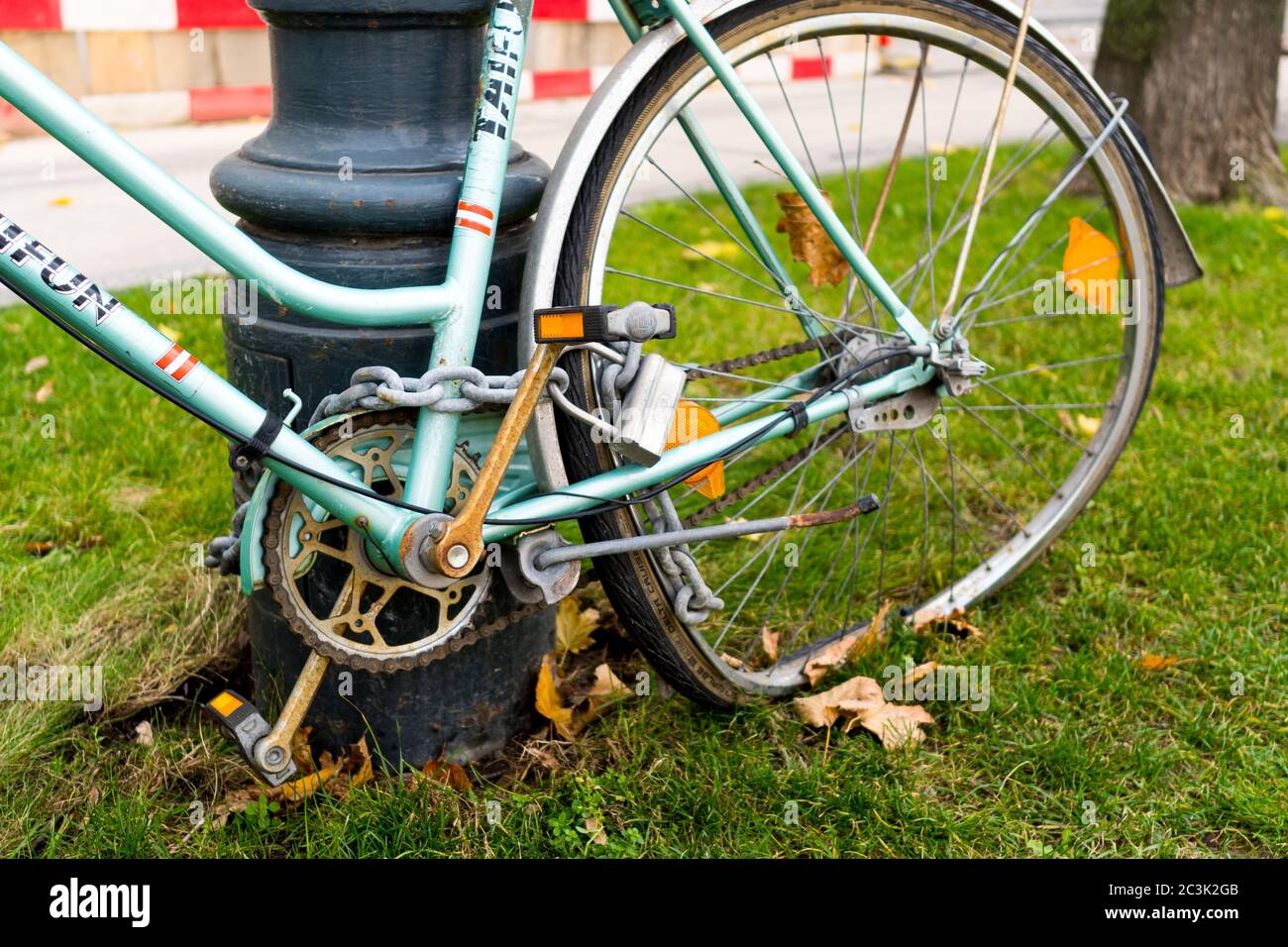 Closeup of a broken bicycle attached to a pillar Stock Photo - Alamy