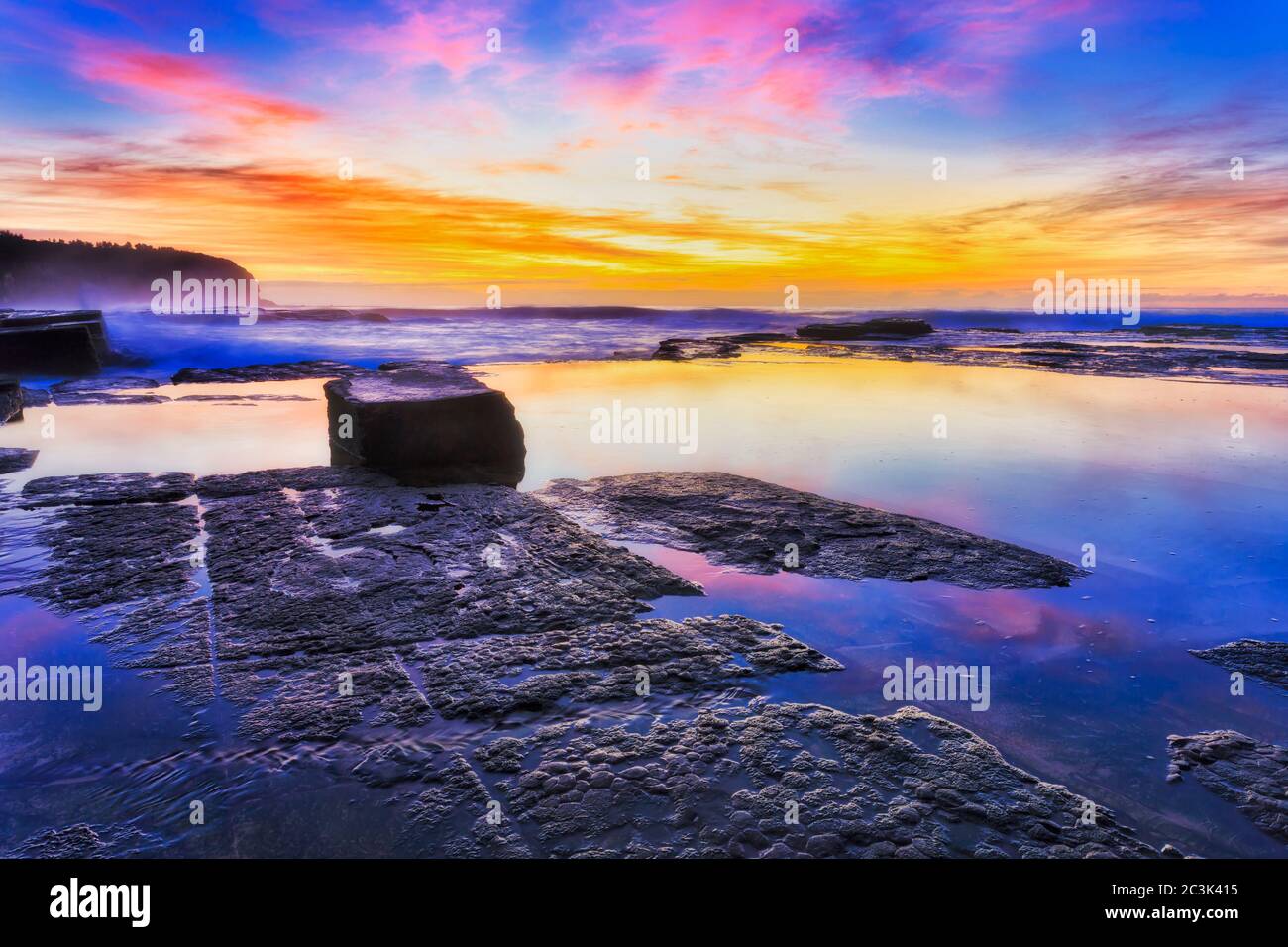 Lonely stone on sandstone plateau of Turimetta beach at dark time of ...