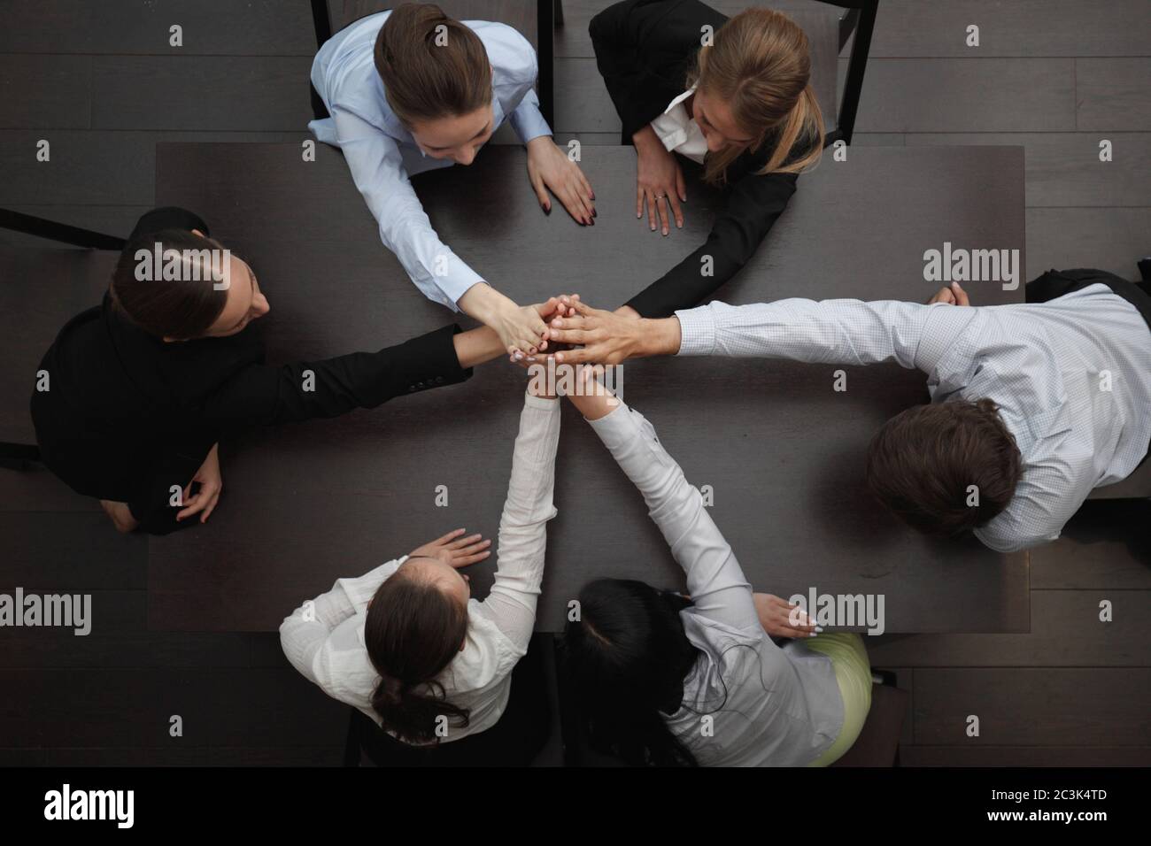 Business team People with their hands stacked together, unity and ...