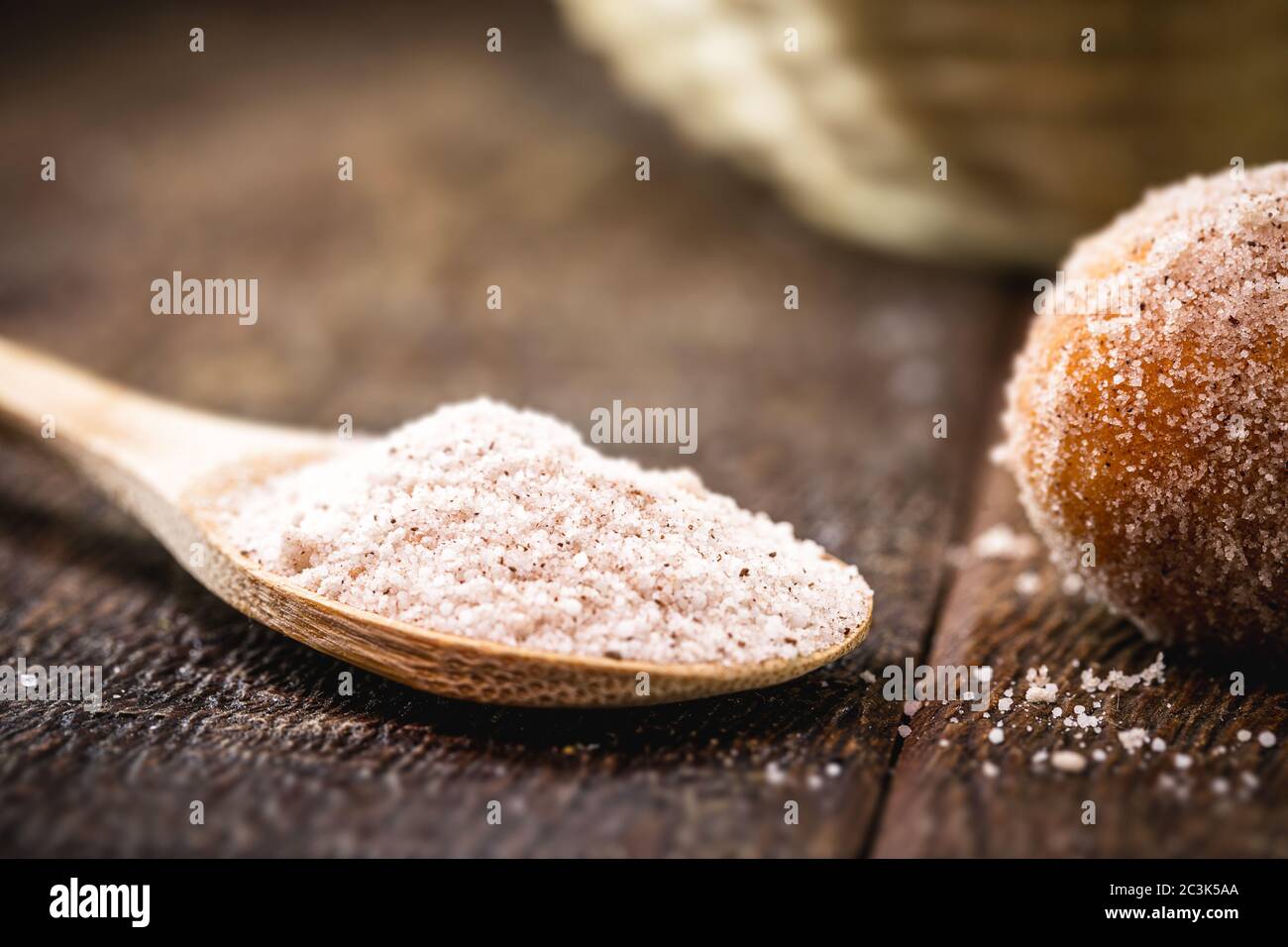 wooden spoon with refined sugar and powdered cinnamon. Typical ...