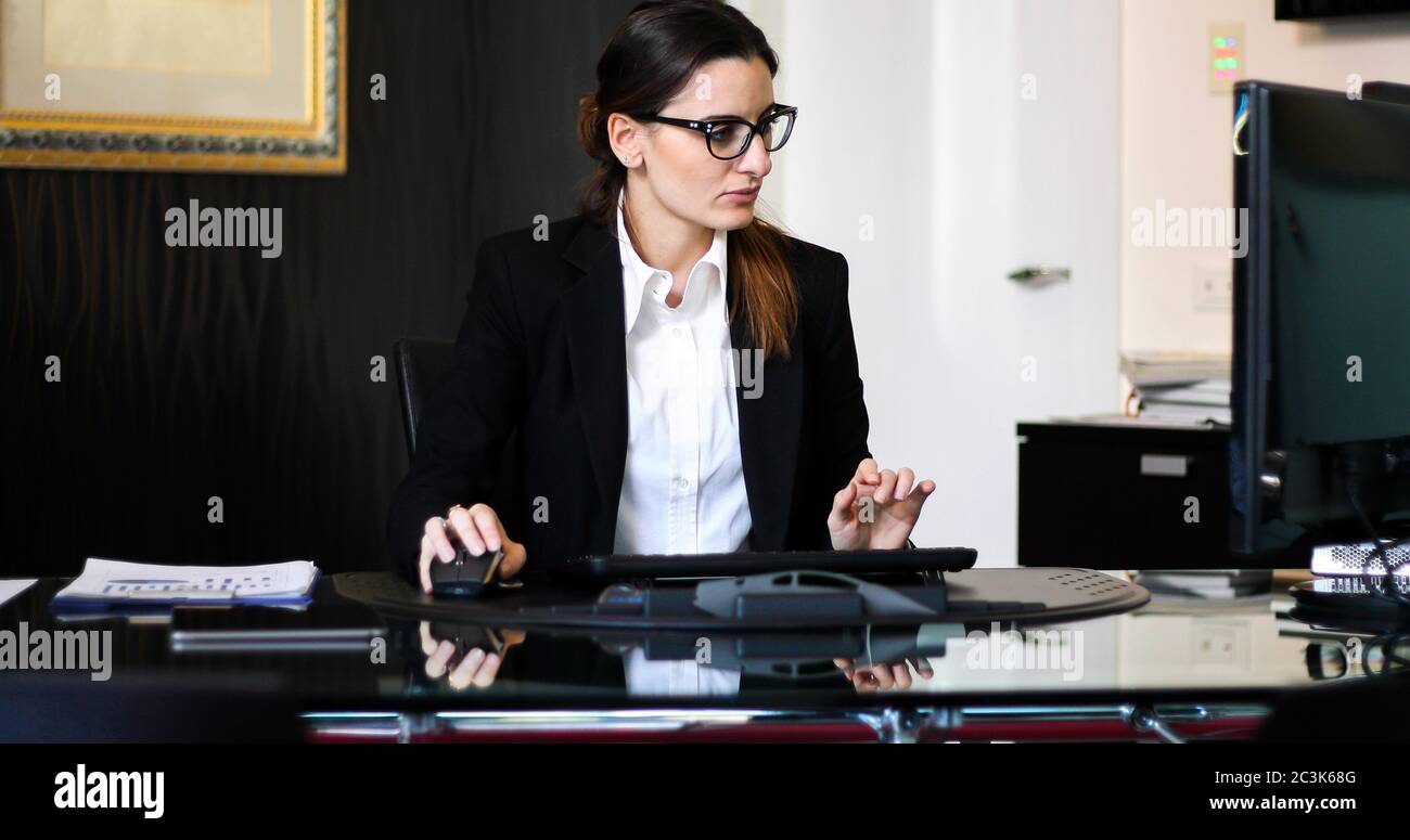 Secretary atg work in her office with a desktop pc Stock Photo - Alamy