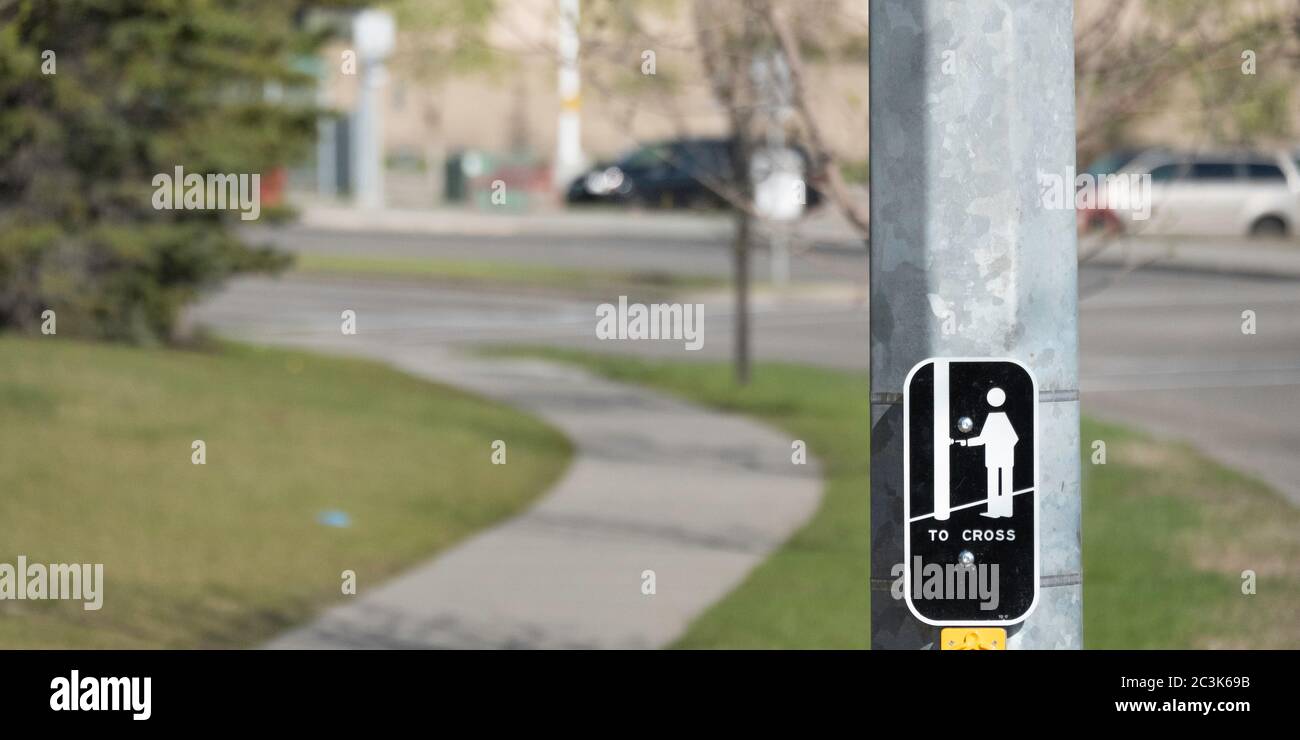 Road crossing sign at street intersection for pedestrians to cross road ...