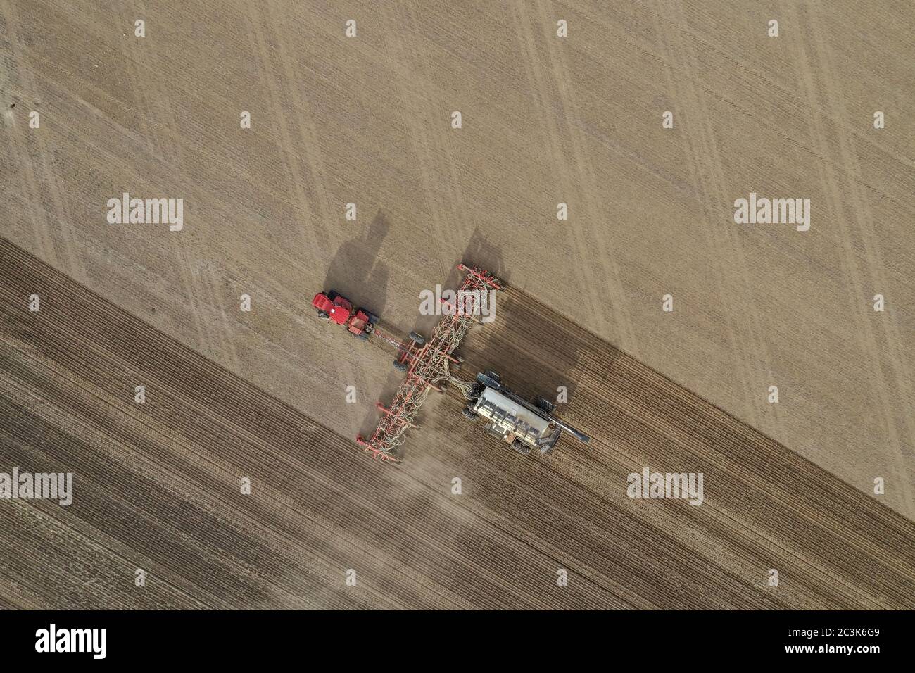 Aerial overhead shot of fertilizer machine in a farming field during ...