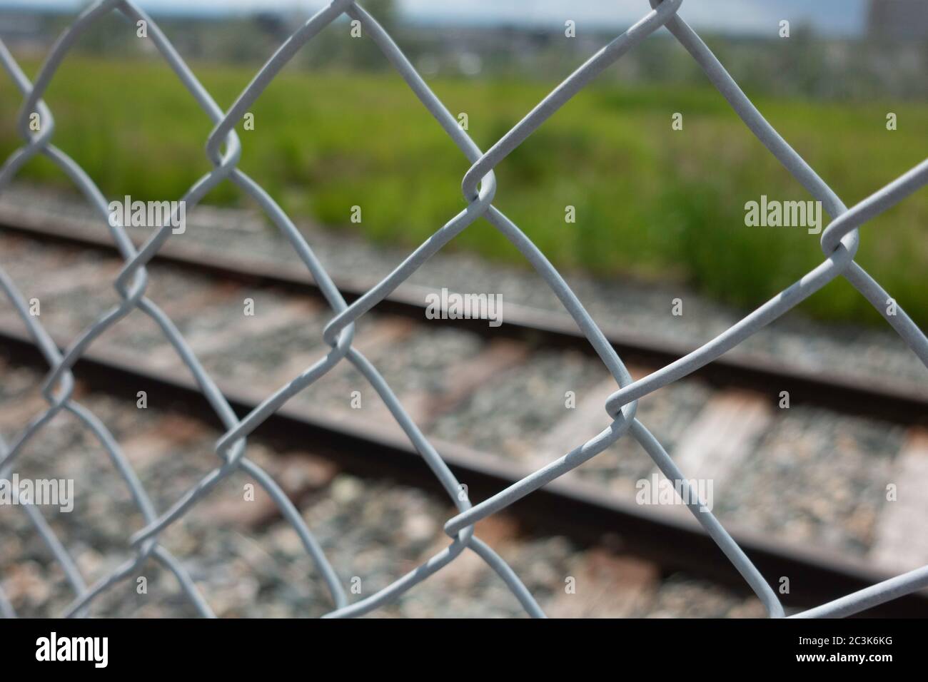 Chain Link Mesh Fence in front of Railway Track Stock Photo - Alamy