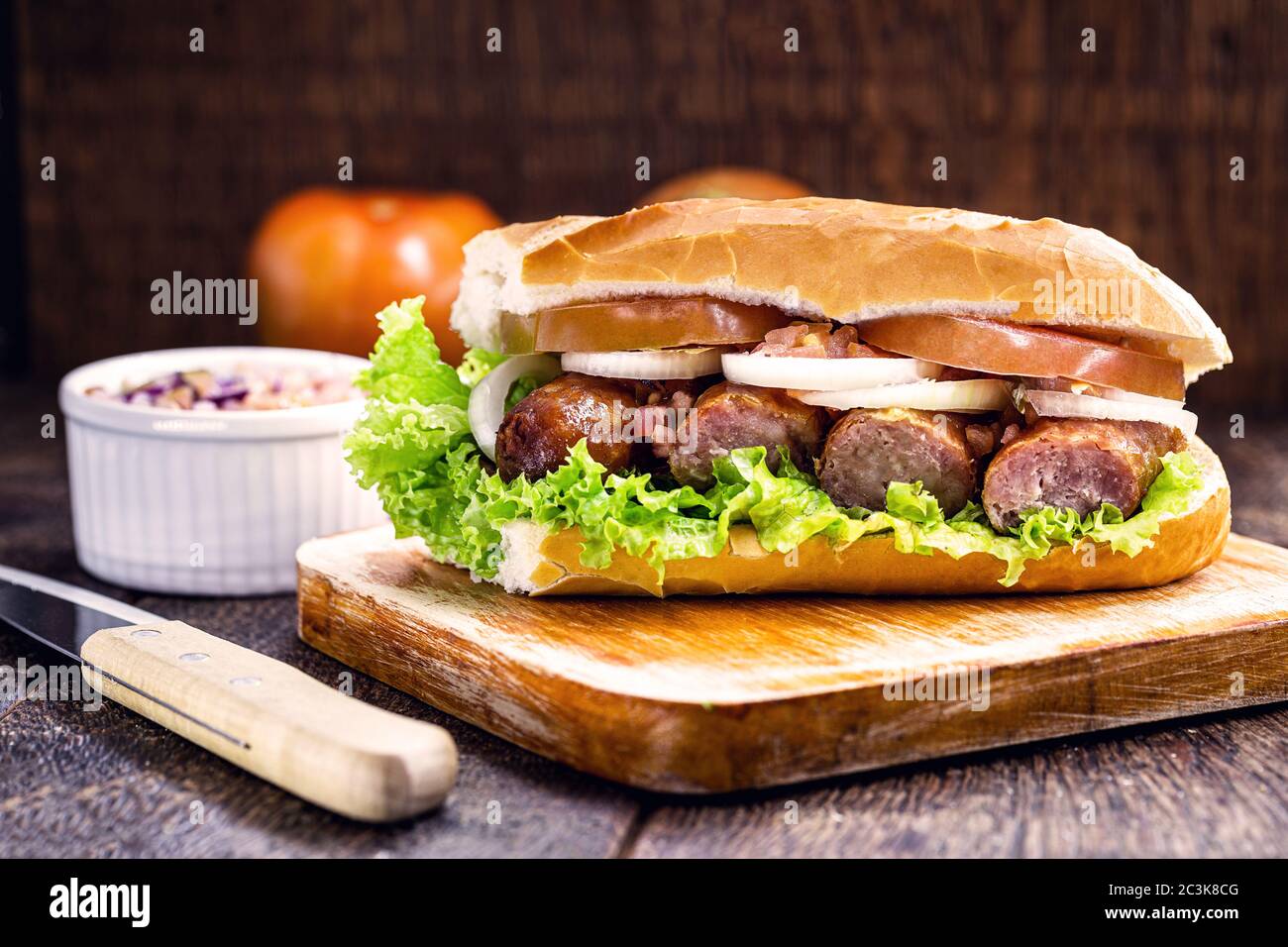 traditional Brazilian sandwich of bread with sausage, tomato, onion and ...