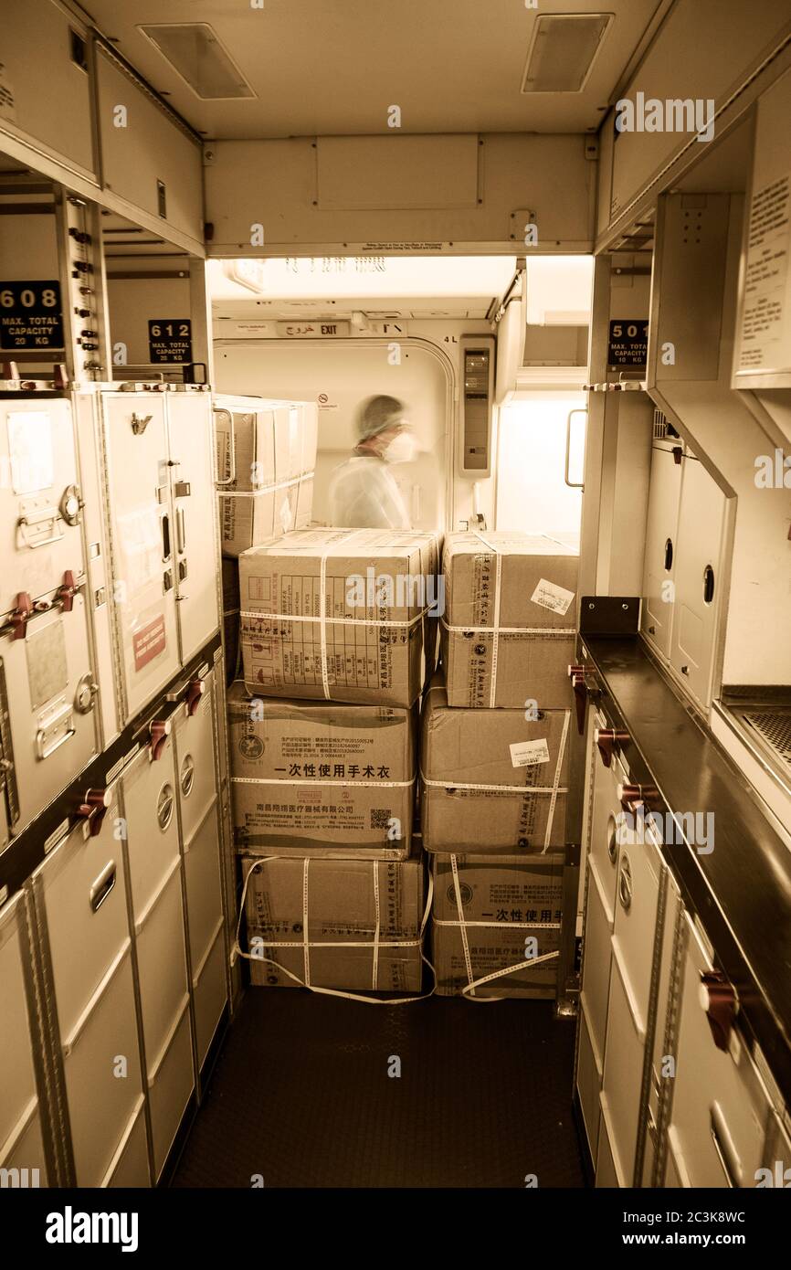 Chinese loader wearing hazmat suits loading a converted passenger into ...