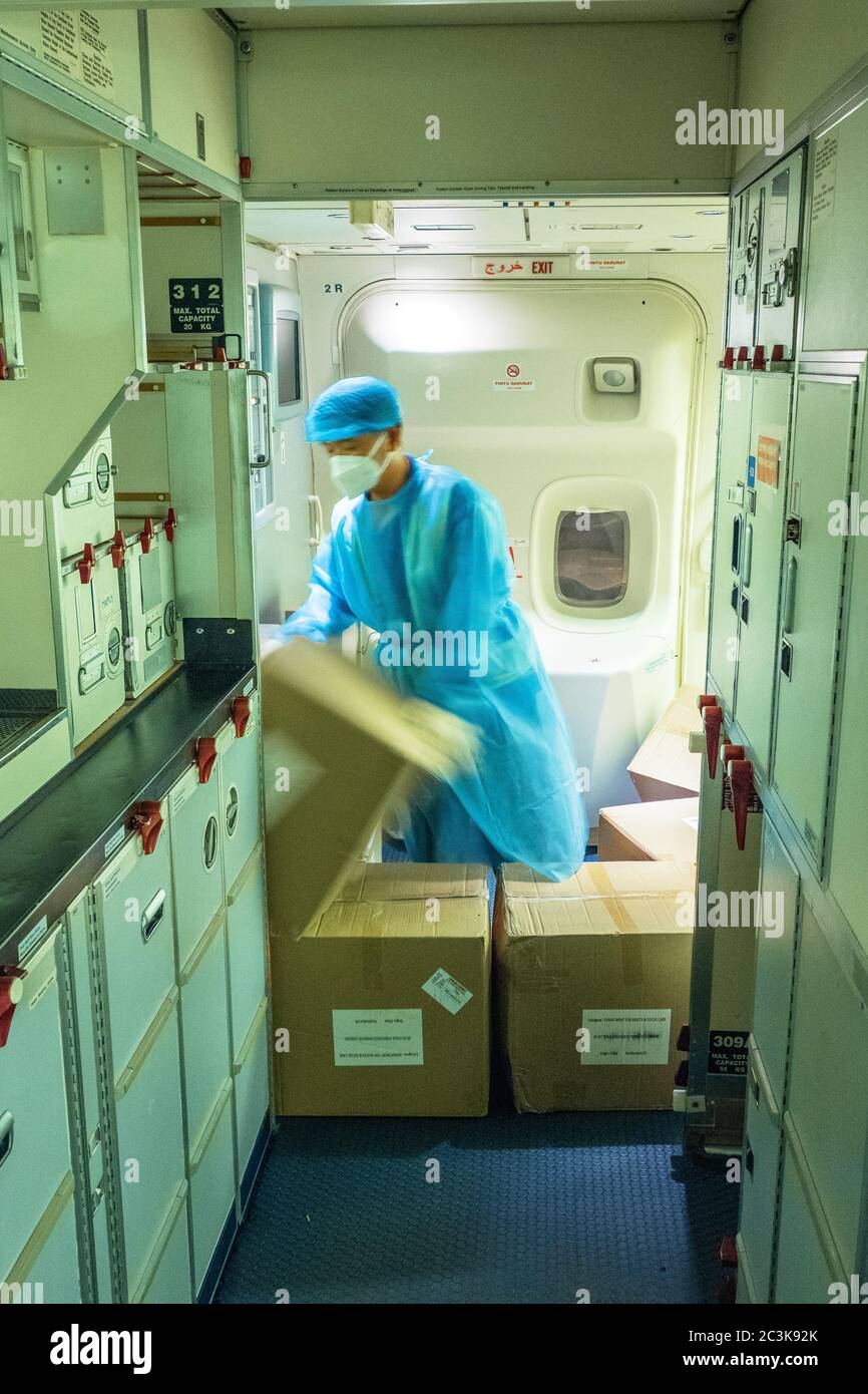 Chinese loader wearing hazmat suits loading a converted passenger into ...