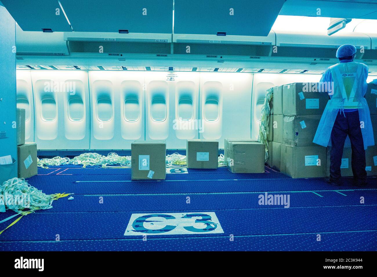 Chinese loader wearing hazmat suits loading a converted passenger into ...