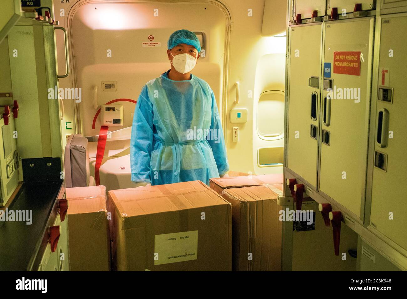 Chinese loader wearing hazmat suits loading a converted passenger into ...