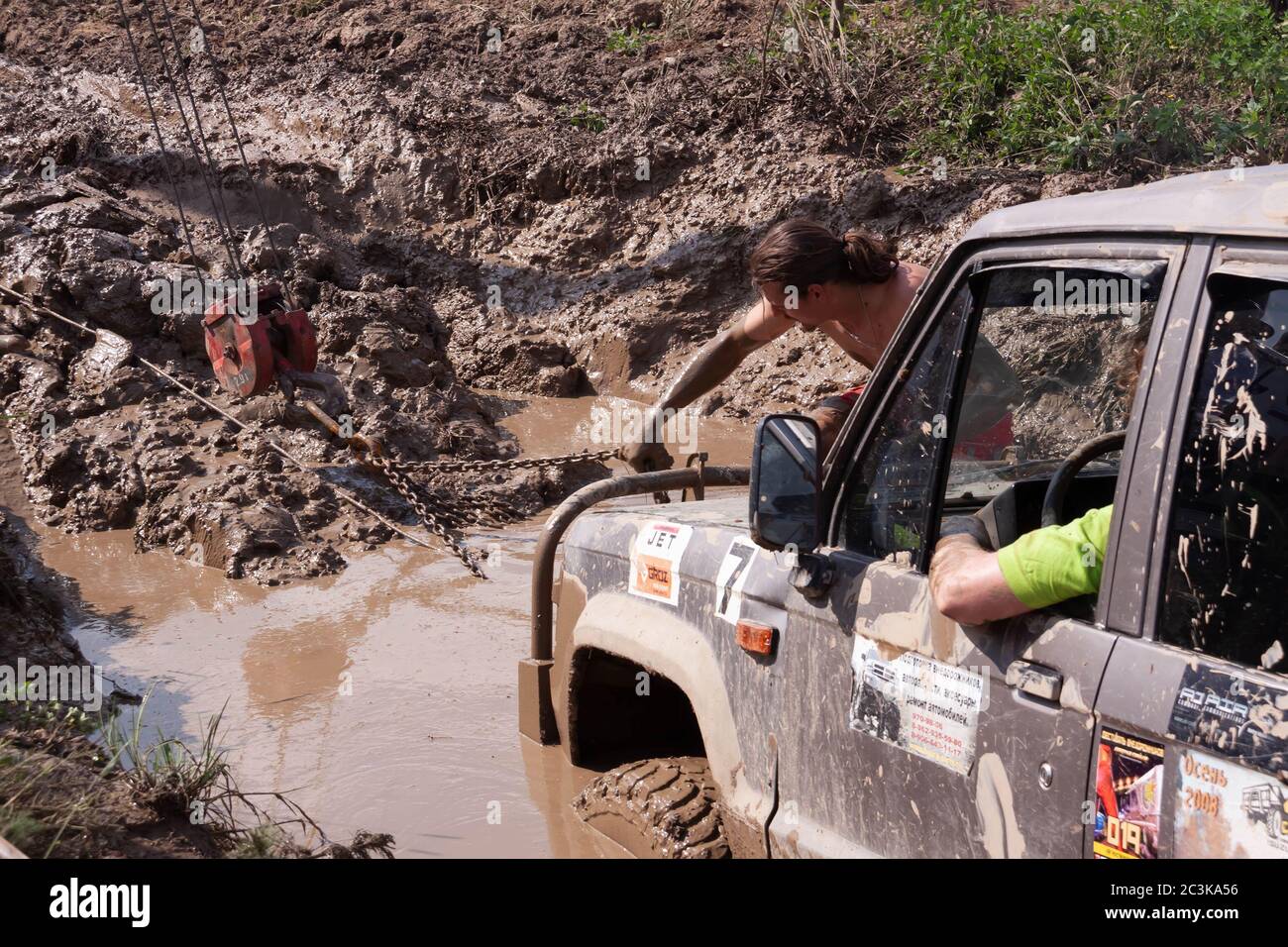 Moscow, Russia - May 25, 2019: A man fastens a chain to a car stuck in ...