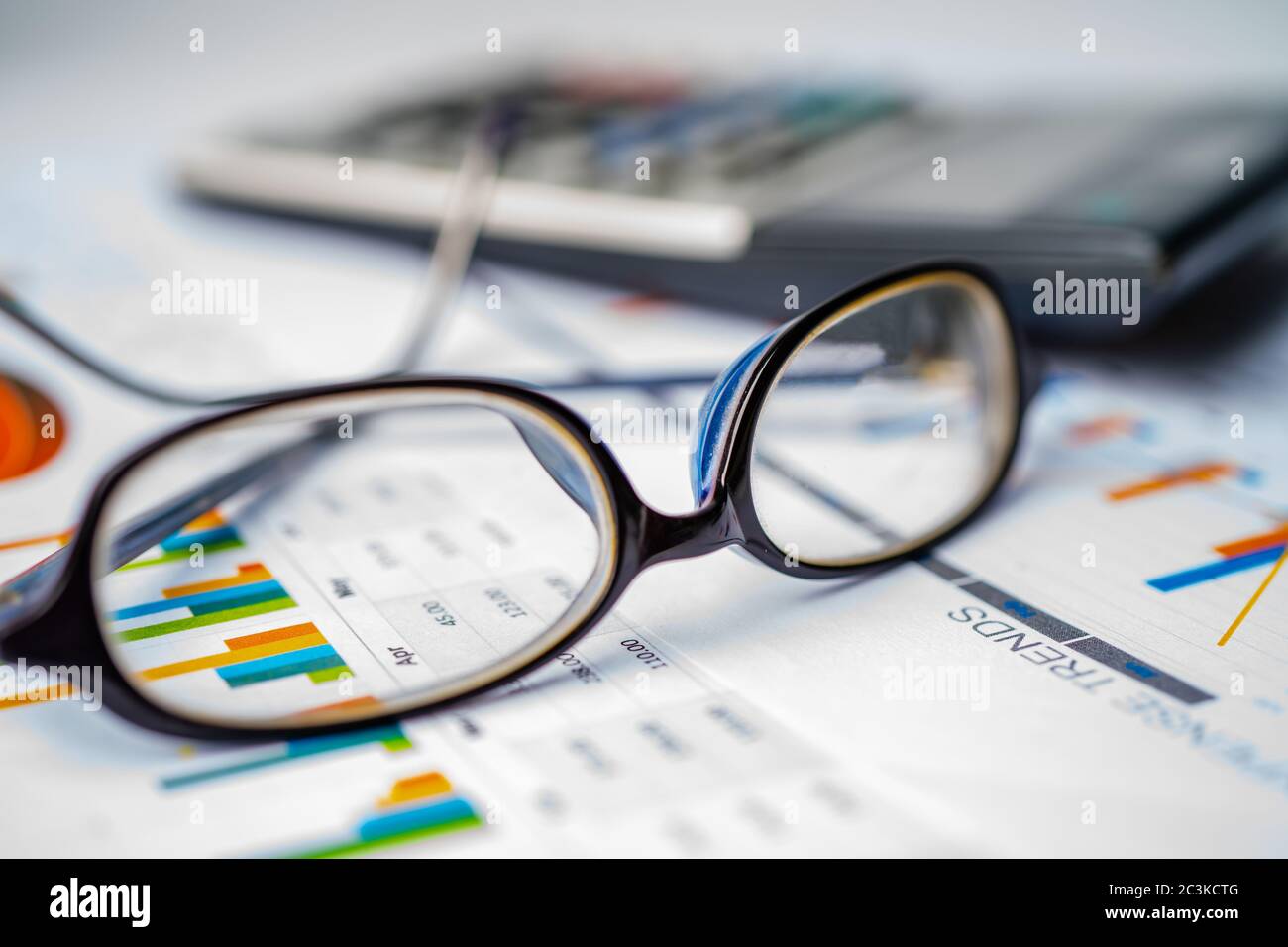 Eyeglass with calculator on chart graph paper background, Banking ...