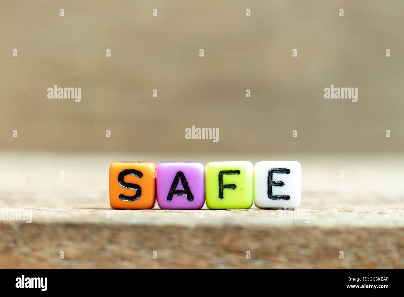Colorful bead with black letter in word safe on wood background Stock ...