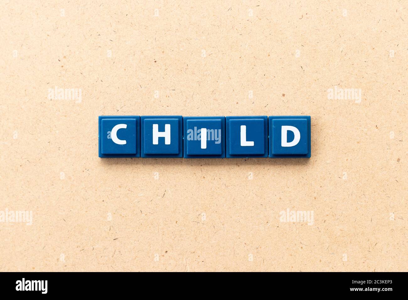 Tile letter in word child on wood background Stock Photo - Alamy