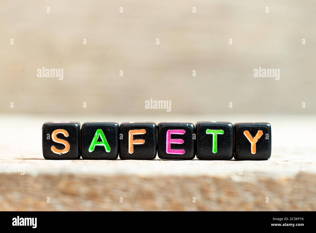 Black bead with color letter in word safety on wood background Stock ...