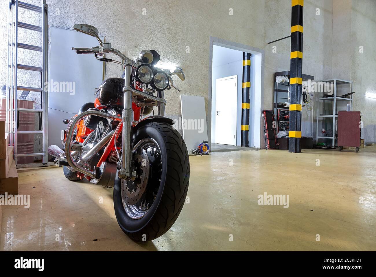 Orange motorcycle service center Stock Photo - Alamy