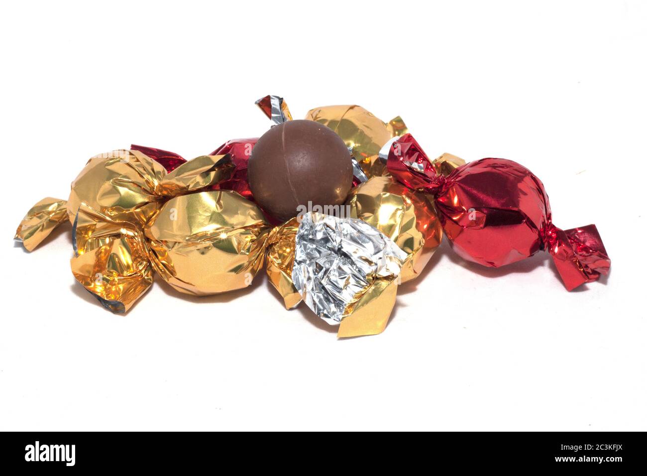 Round chocolate candy with foil packaging isolated on the white ...