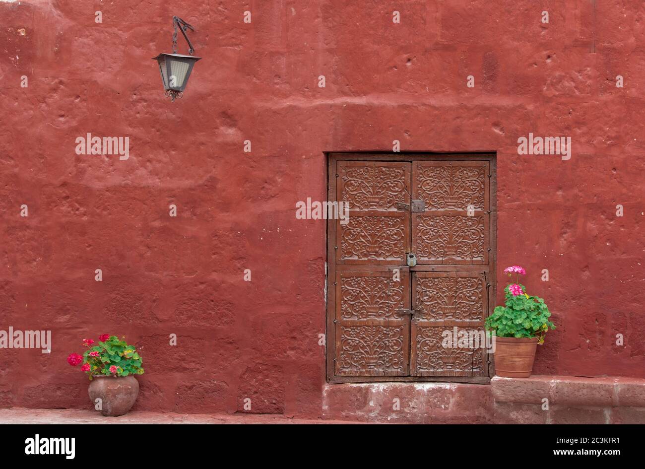 AREQUIPA, PERU - JANUARY 17, 2018: Beautiful ancient door with flower ...