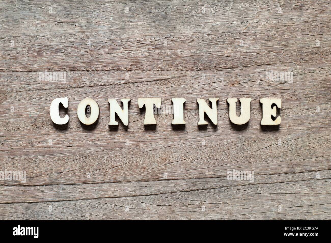 Alphabet letter block in word continue on wood background Stock Photo ...