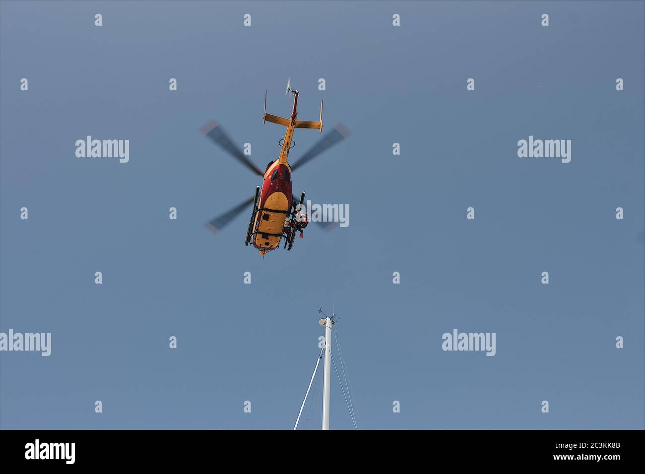 Low angle shot of a helicopter under a clear blue sky Stock Photo - Alamy