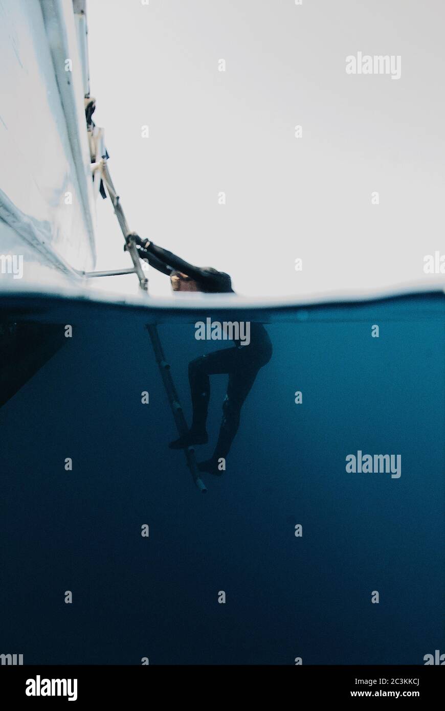 Vertical shot of a person going down the steps ready to start diving ...