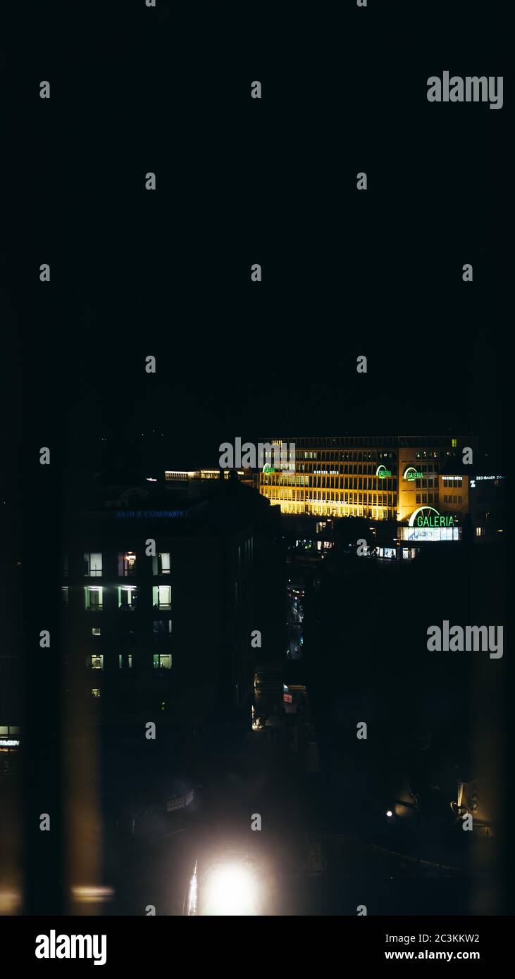 Vertical picture of a building with lights at night Stock Photo - Alamy