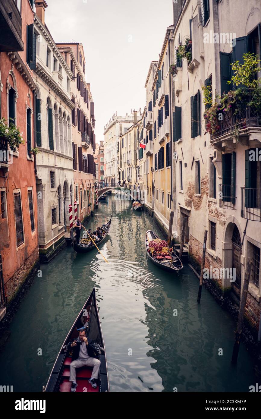 Vertical picture of gondolas on the grand channel between colorful ...