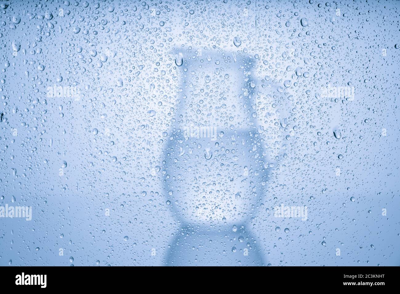 Pitcher with drinking water and a glass with a drink behind a glass ...