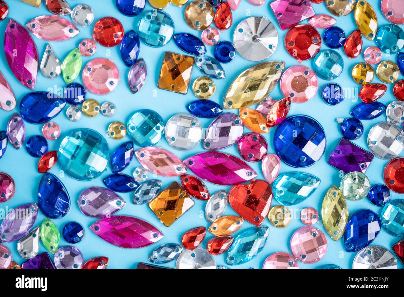 colored rhinestones on a turquoise background, color texture Stock ...
