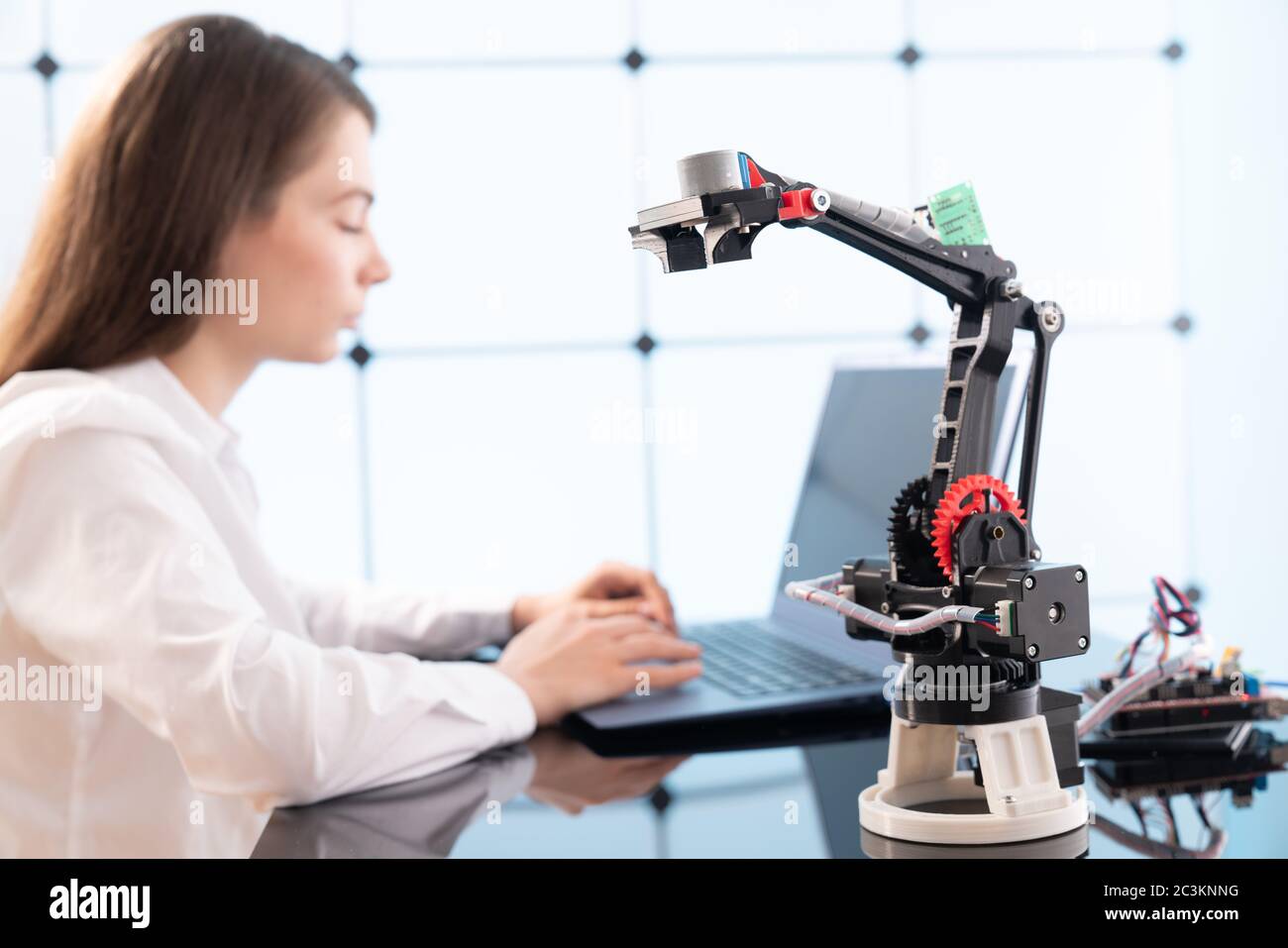 Woman student with robot model arm in university laboratory Stock Photo ...
