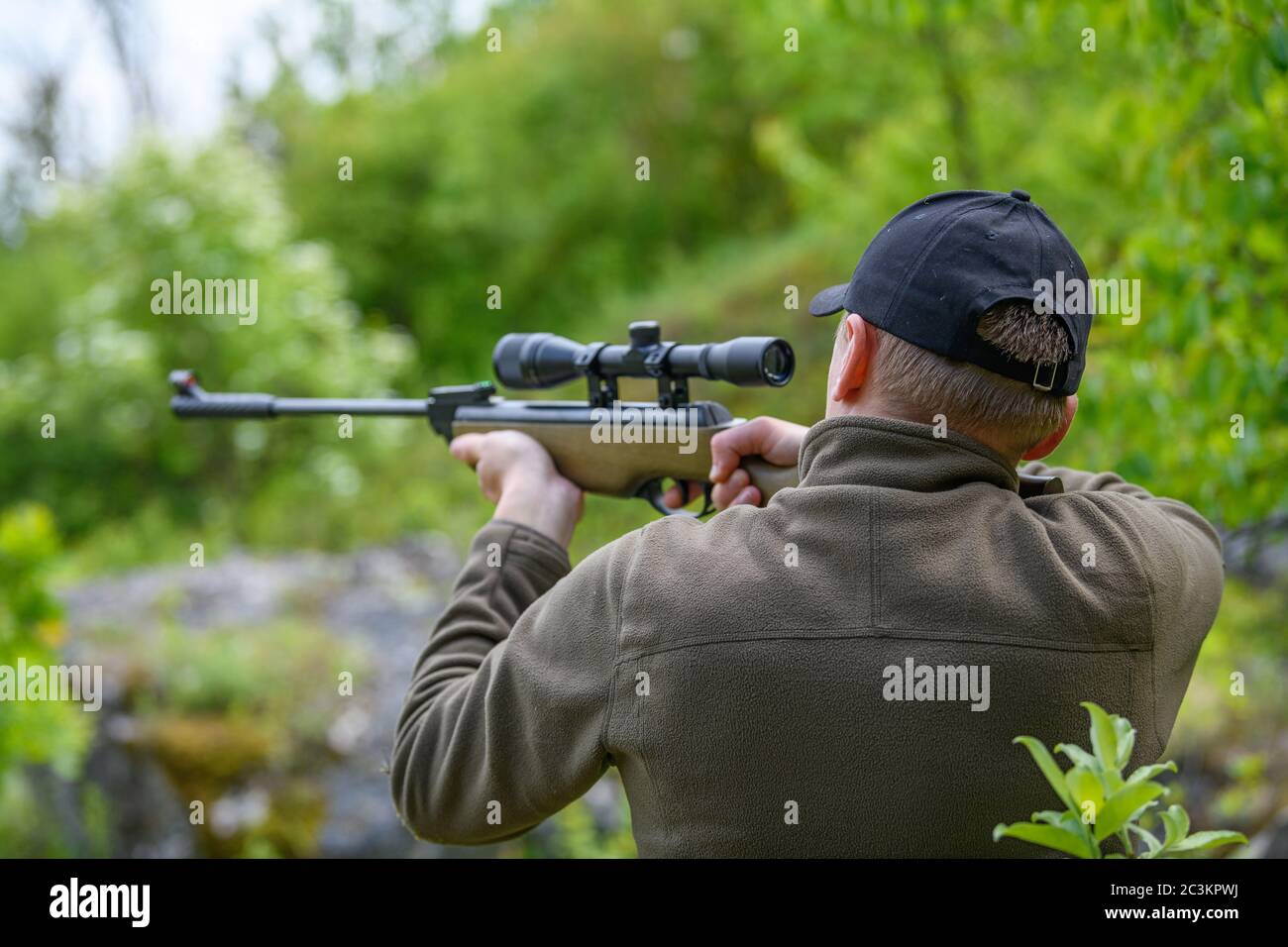 Close male with a gun in hunting period. Hunter in camouflage clothes ...