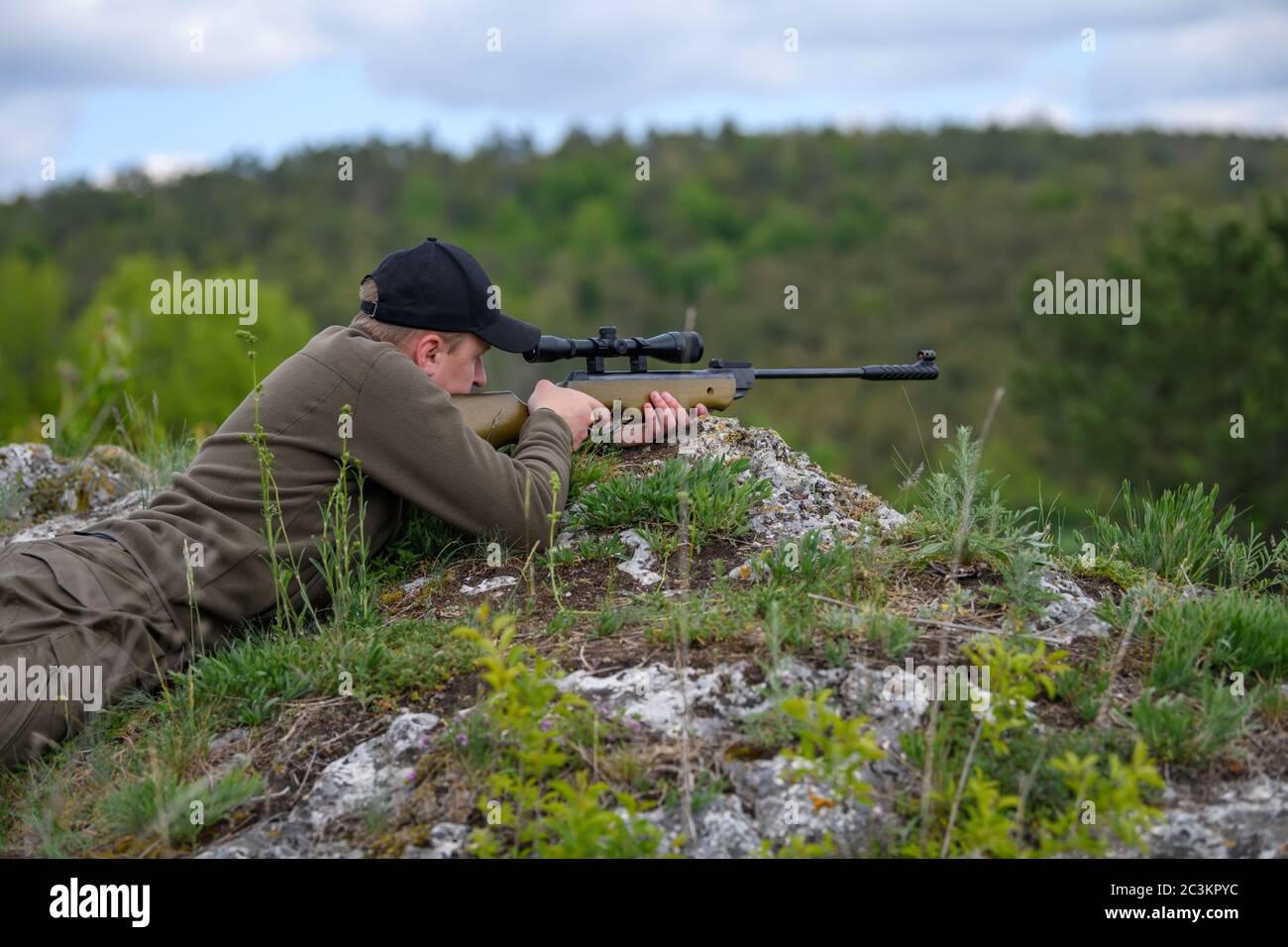 Close male with a gun in hunting period. Hunter in camouflage clothes ...