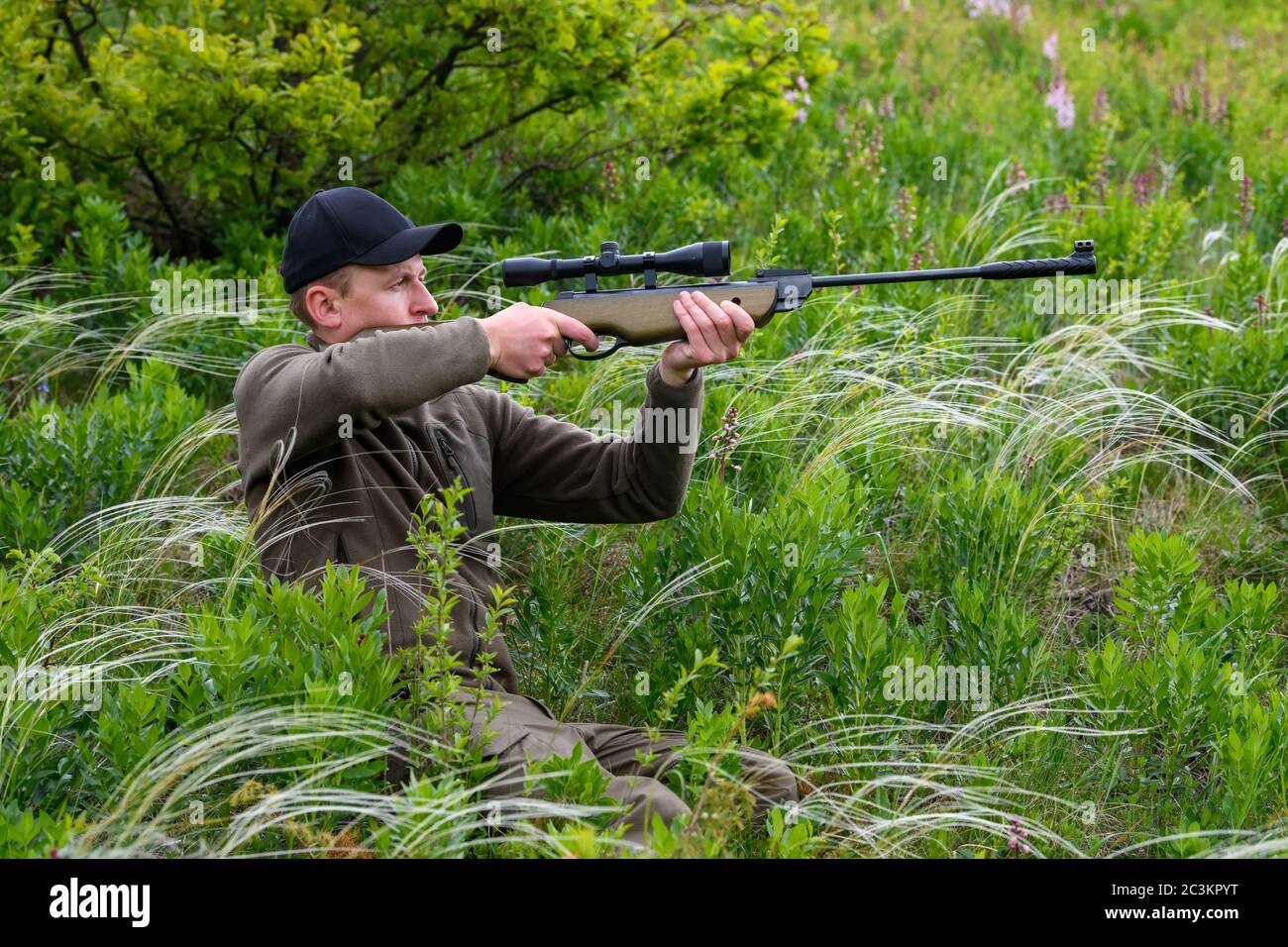 Close male with a gun in hunting period. Hunter in camouflage clothes ...