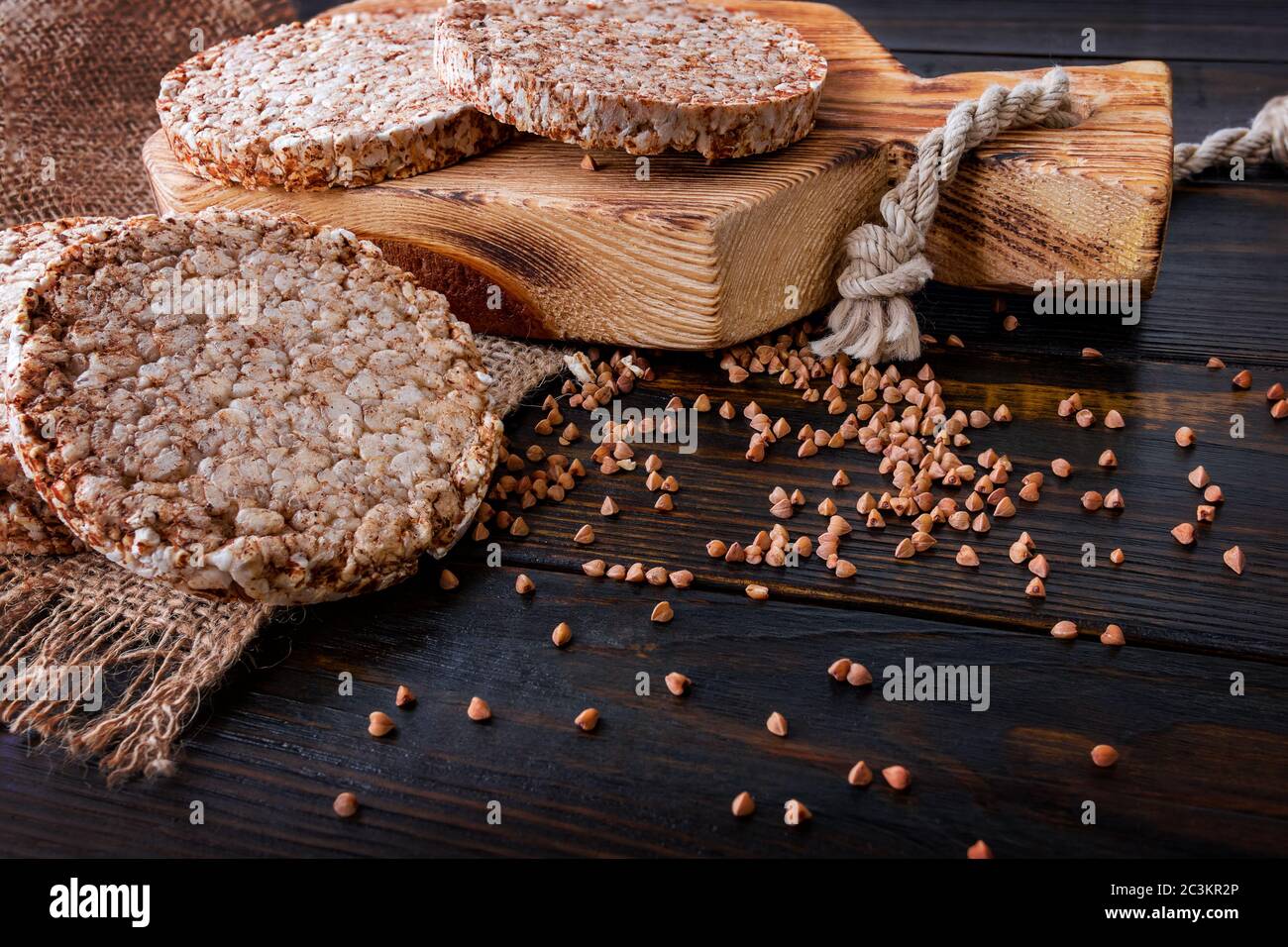 Airy, round, crisp buckwheat crispbread on wooden background with ...