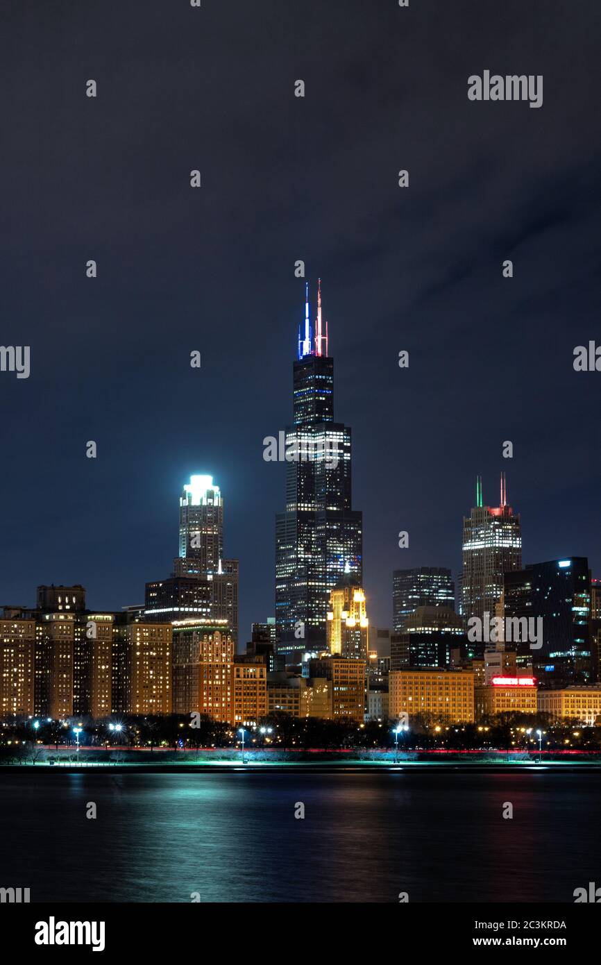 Vertical shot of the lights on the buildings and skyscrapers captured ...