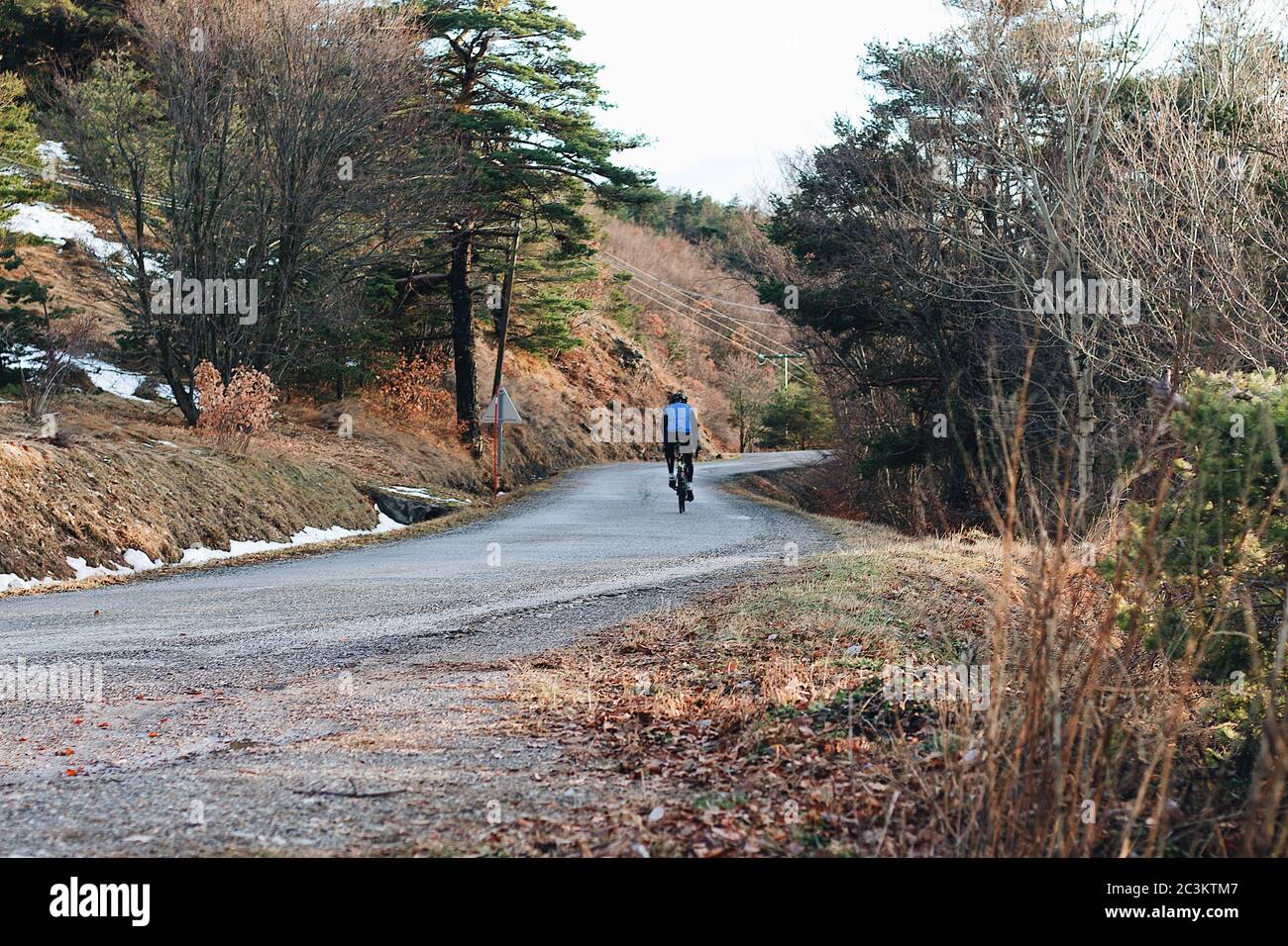 Man with a backpack driving a bicycle Stock Photo - Alamy