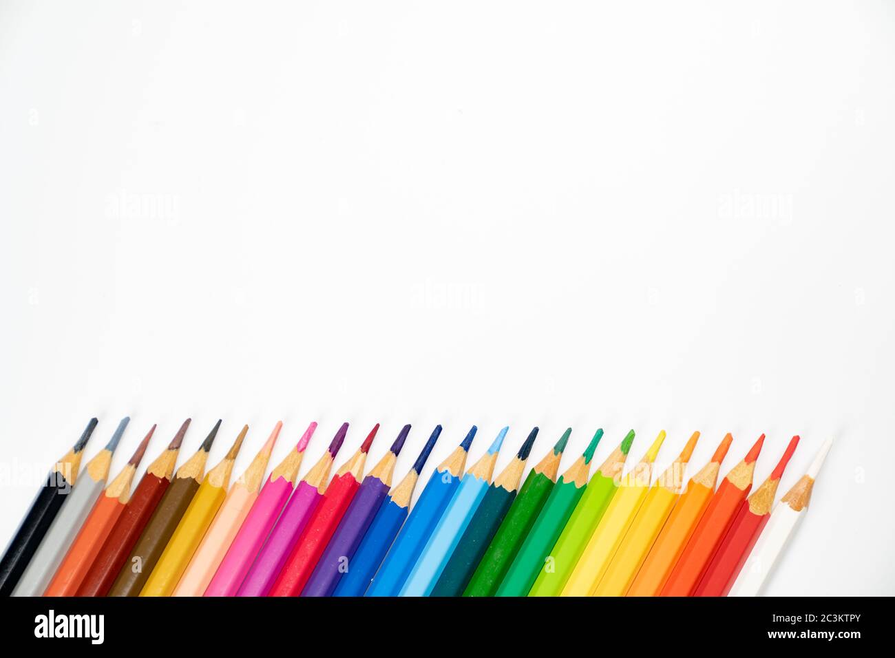 blunt colour pencils are arranged in the line on the white background ...
