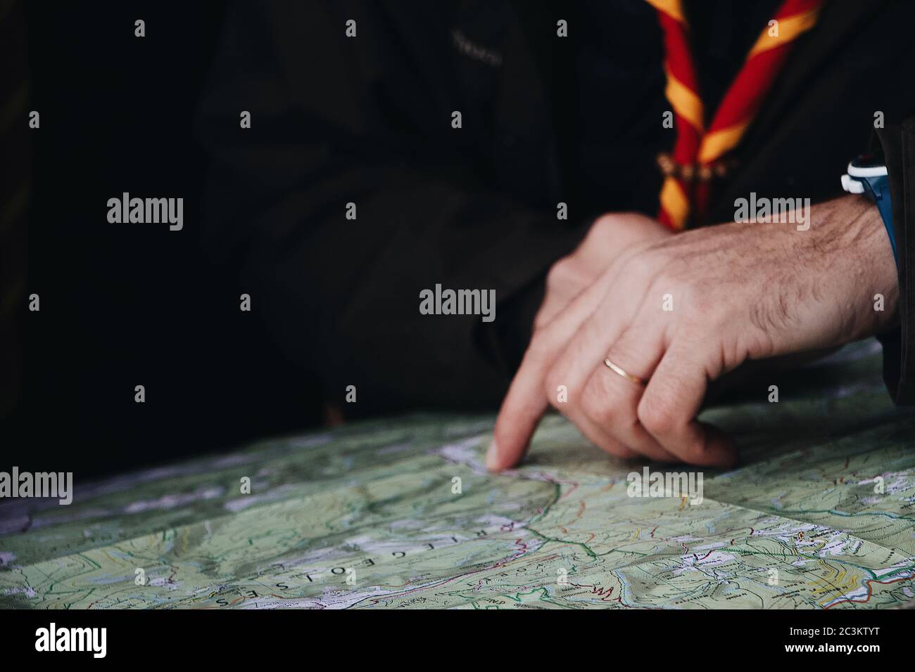 Person's hand pointing a location on a map Stock Photo - Alamy
