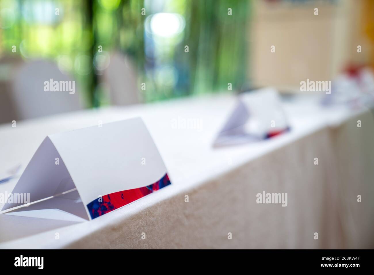 Standy triangle paper stands on the white cover table for identify the ...