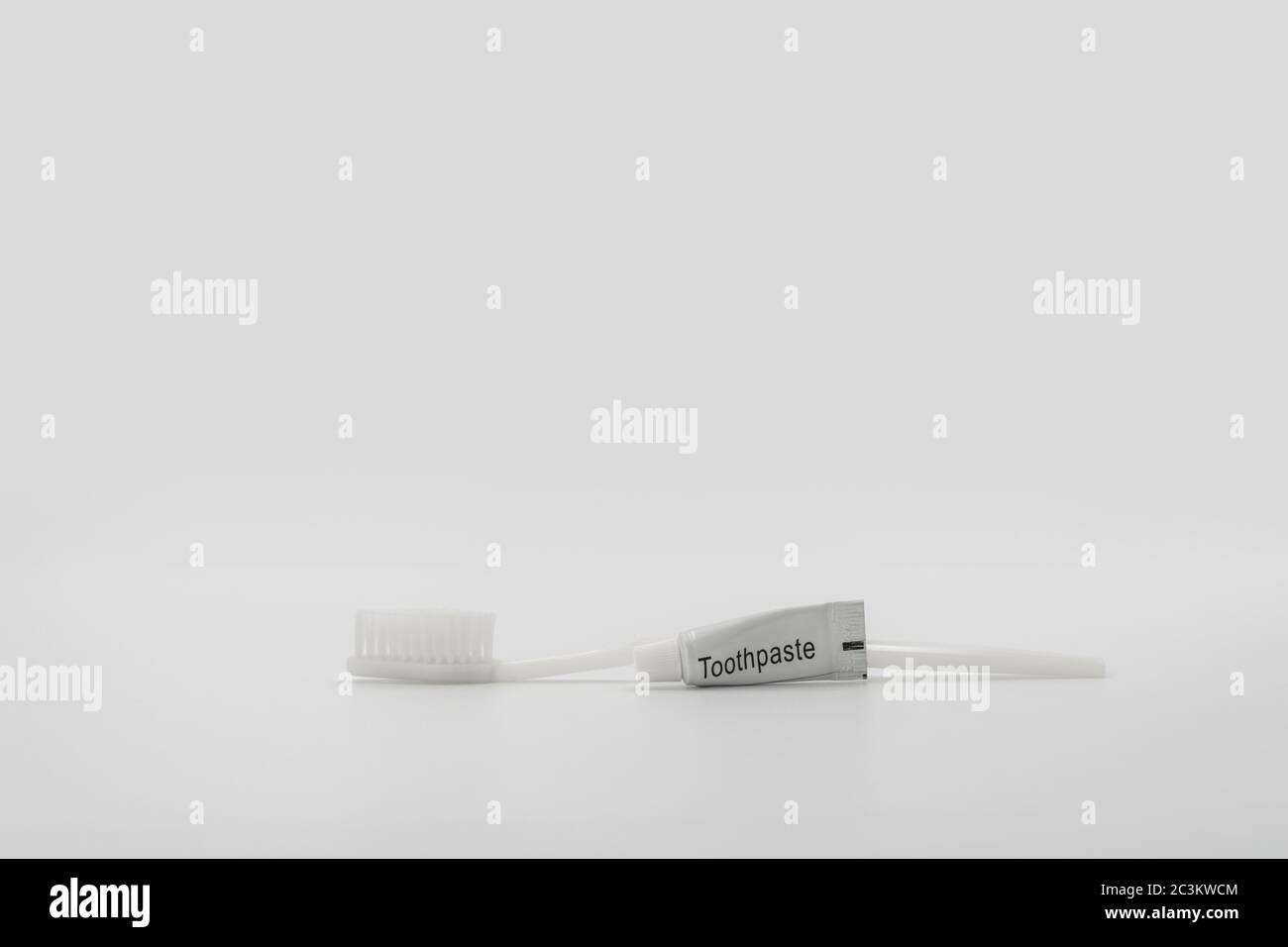 Isolated simple and normal white toothbrush with small toothpaste on ...