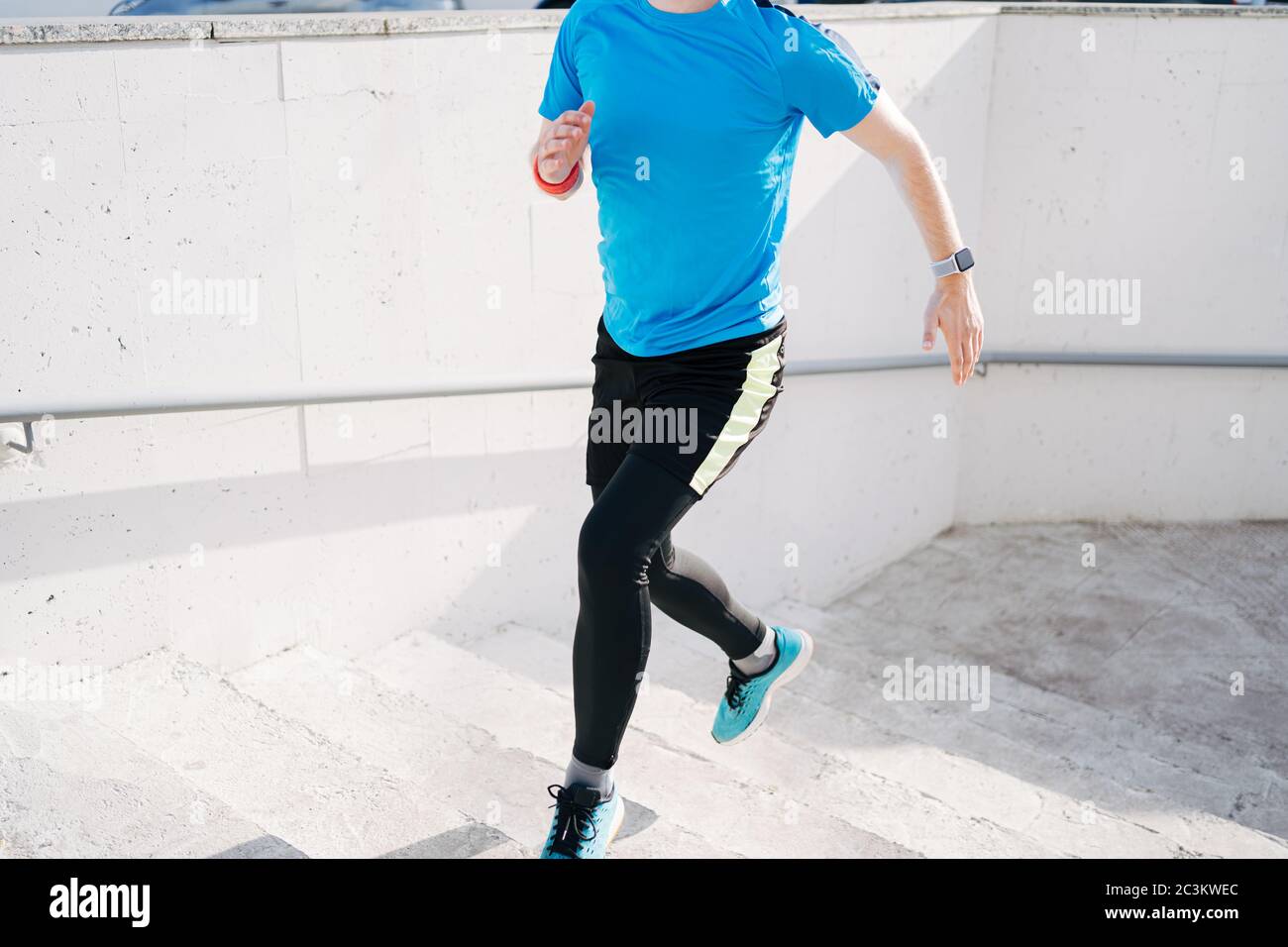 Young man running upstairs on city stairs. Fitness, sport, people ...