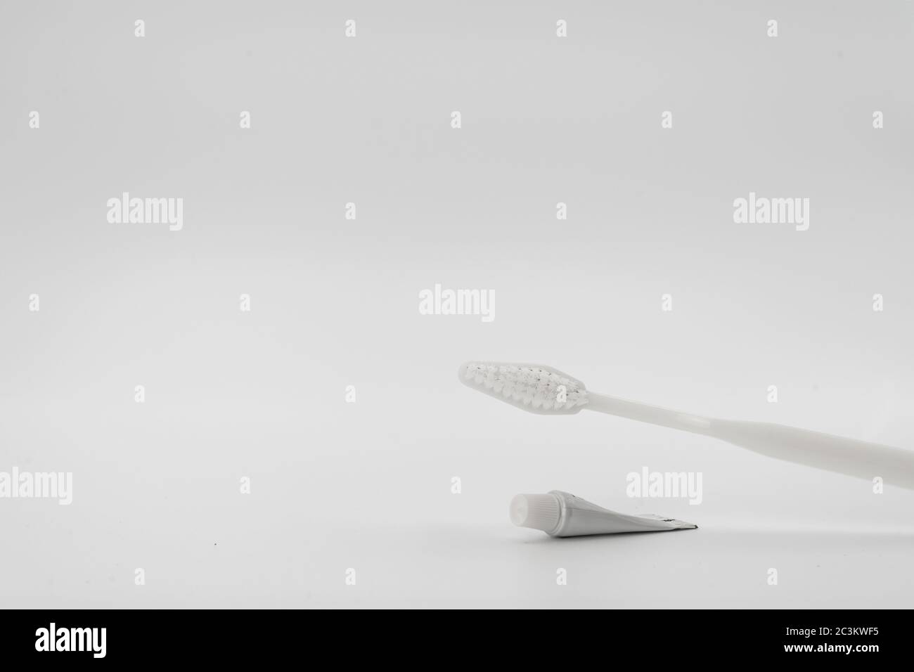 Isolated simple and normal white toothbrush with small toothpaste on ...